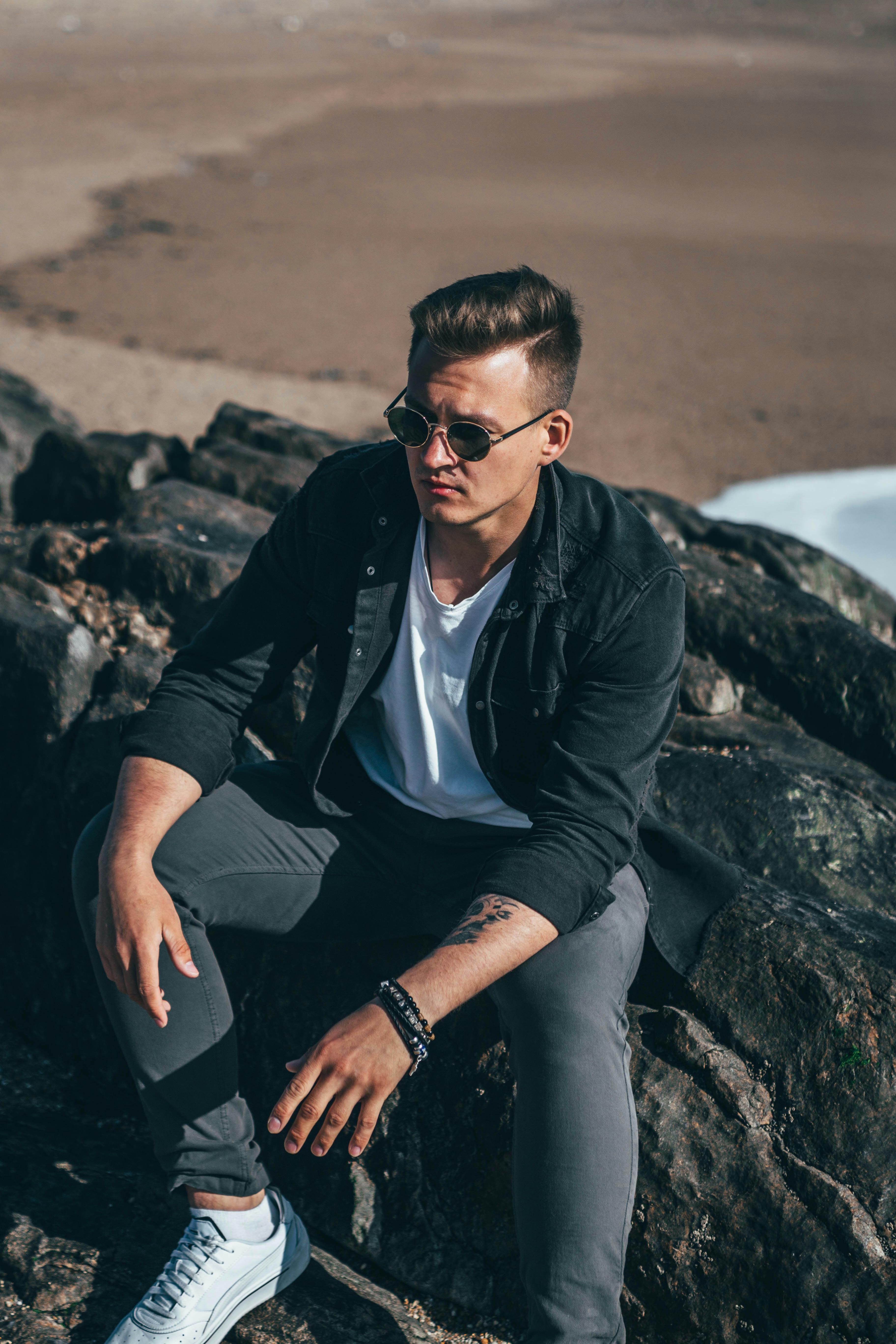 Young Man Sitting on a Stadium Seat · Free Stock Photo