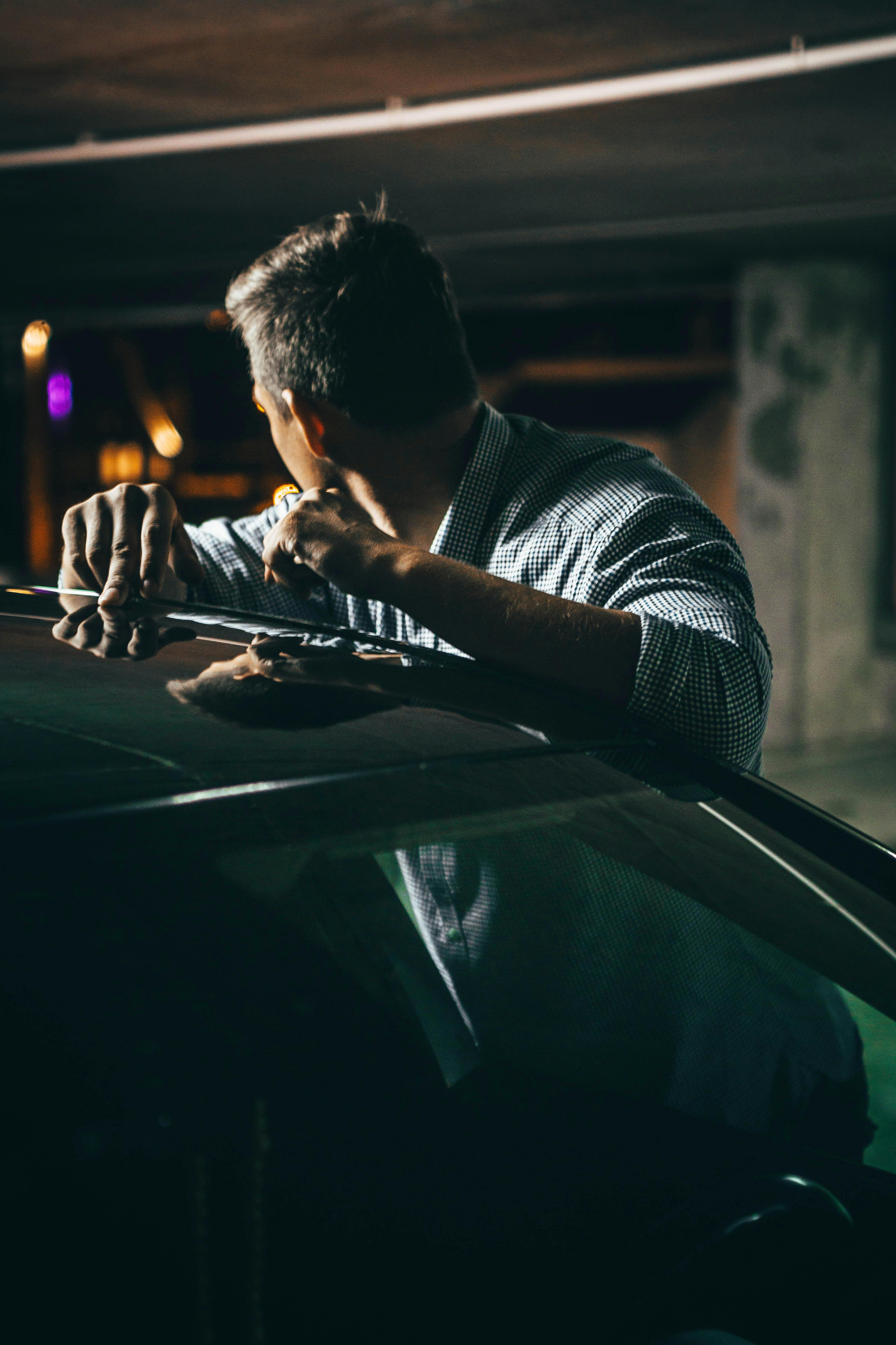 Man With Curly Hair Leaning on a Dashboard Inside Car · Free Stock Photo