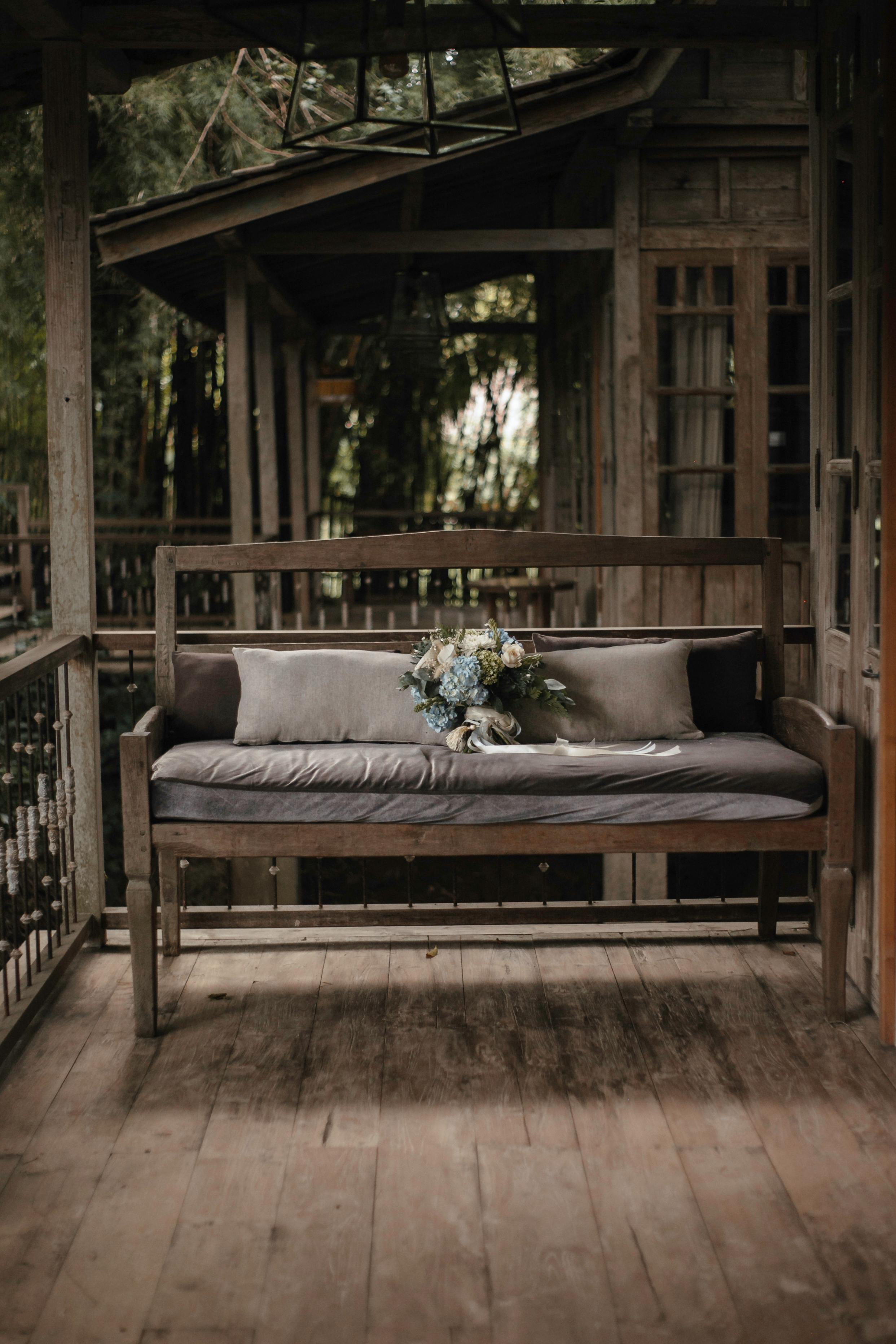 Bench on a Porch of a Wooden Hut · Free Stock Photo