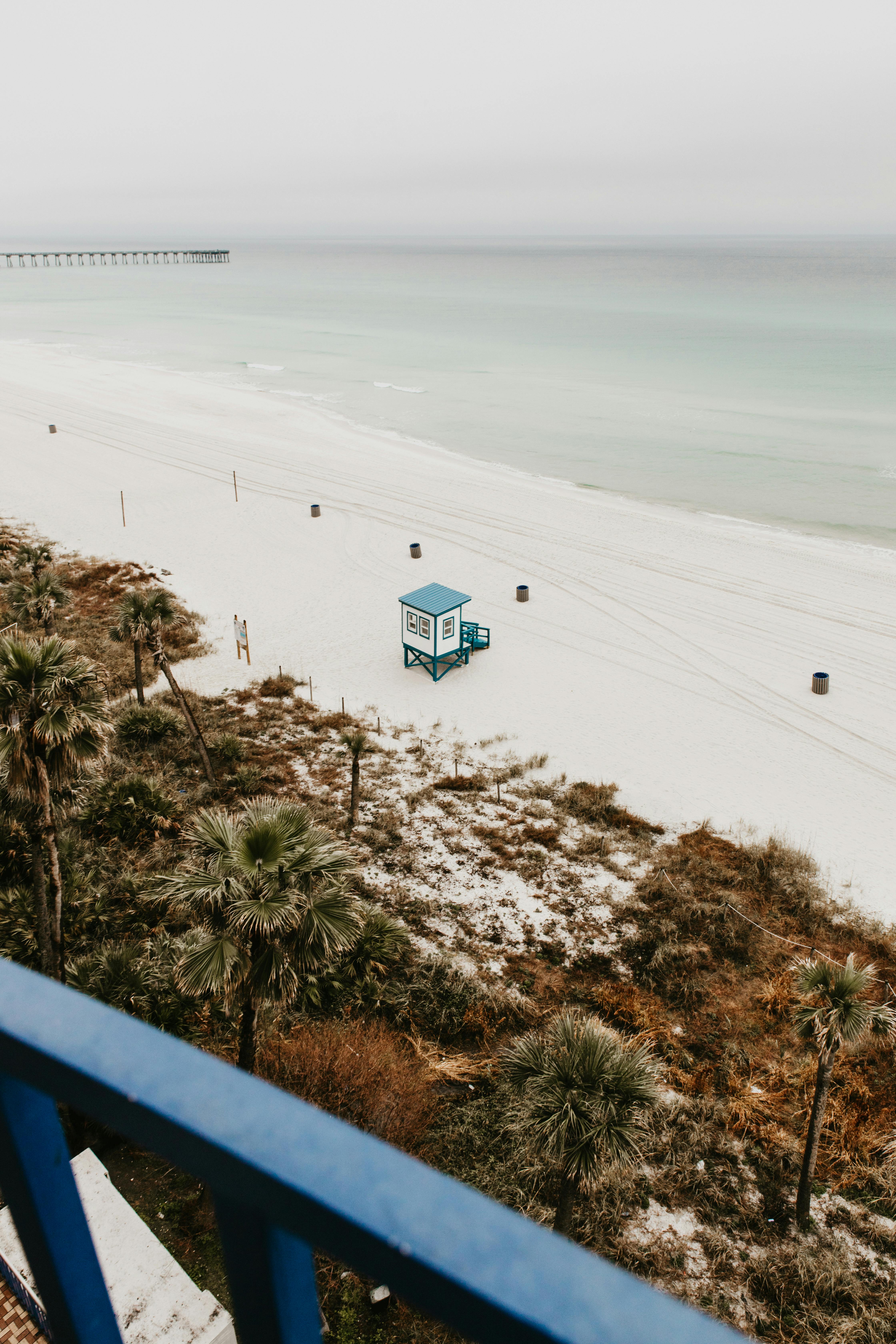 A White and Blue Lifeguard Shack on the Shore · Free Stock Photo
