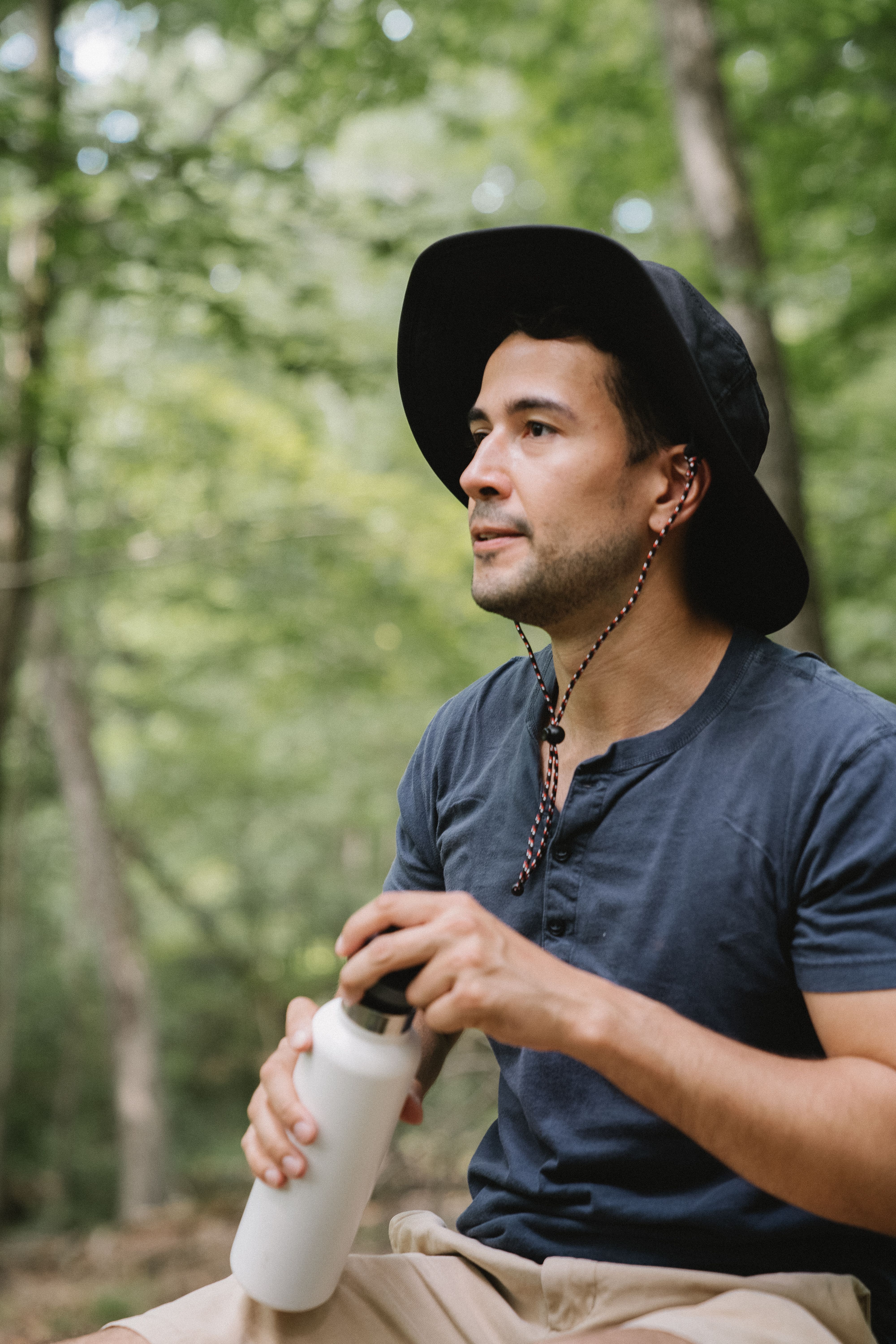 Man in Black Hat Holding Water Bottle · Free Stock Photo