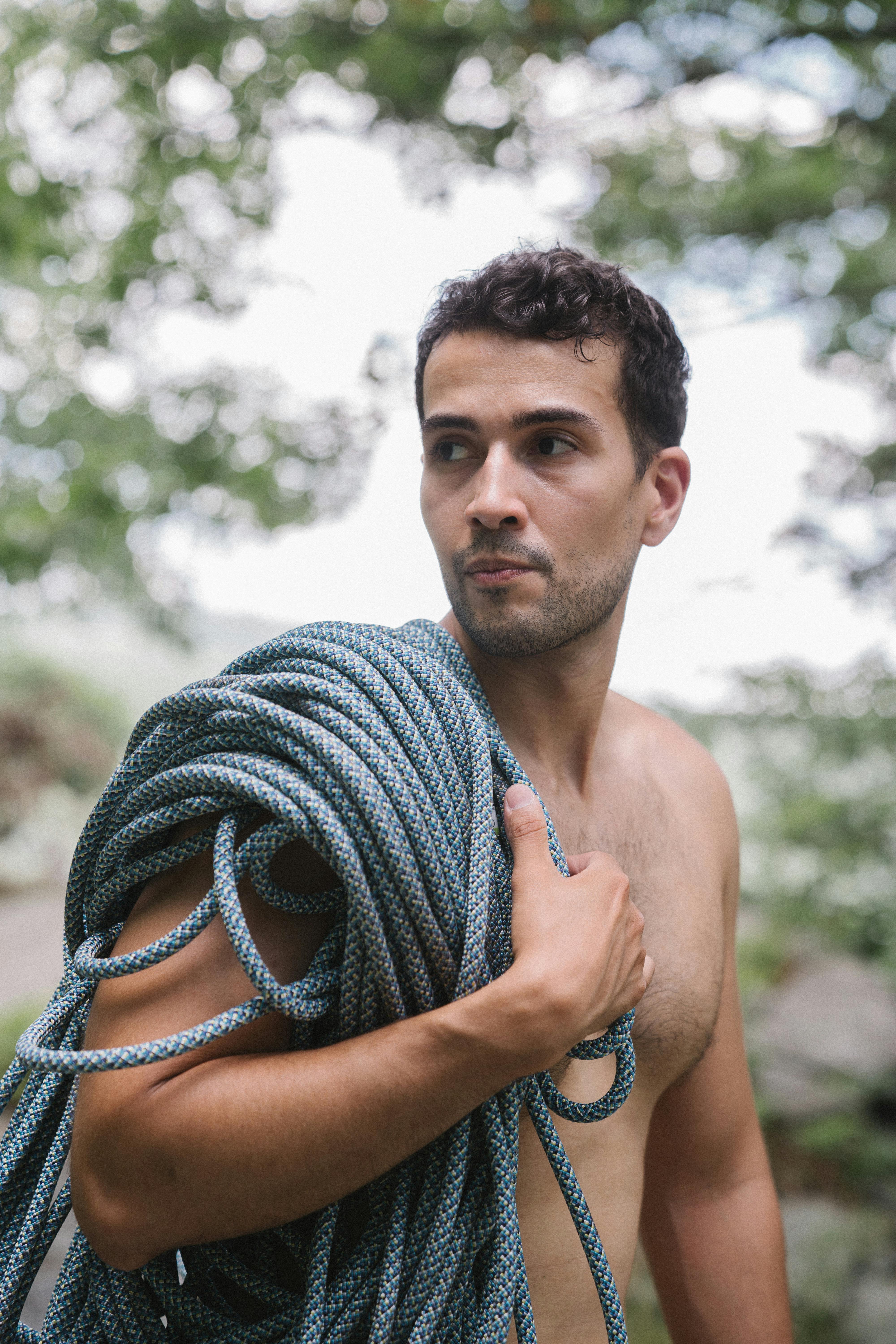 A Shirtless Man Carrying Rope · Free Stock Photo