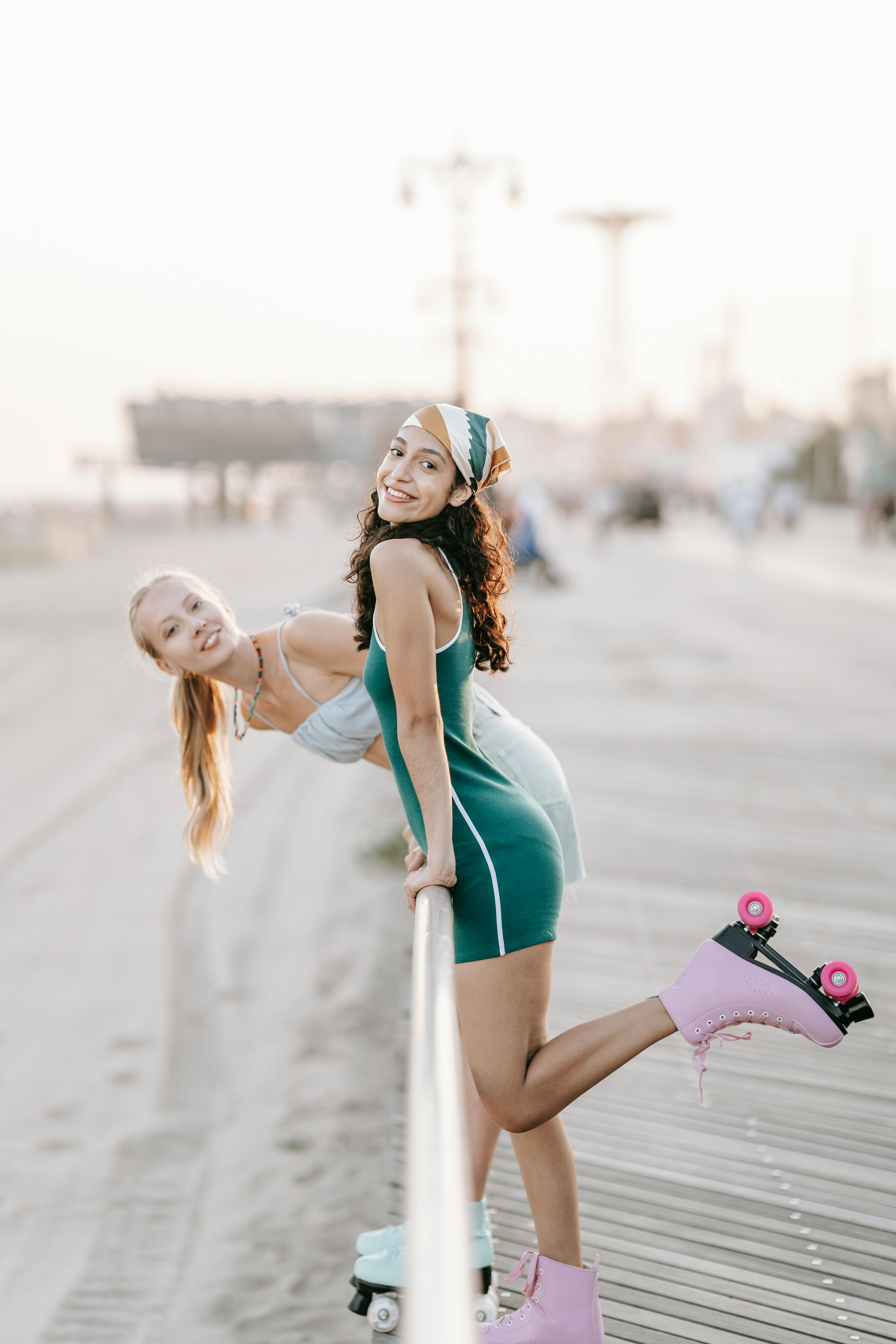 Selective Focus Photo of Two Women in Roller Skates Leaning on a ...