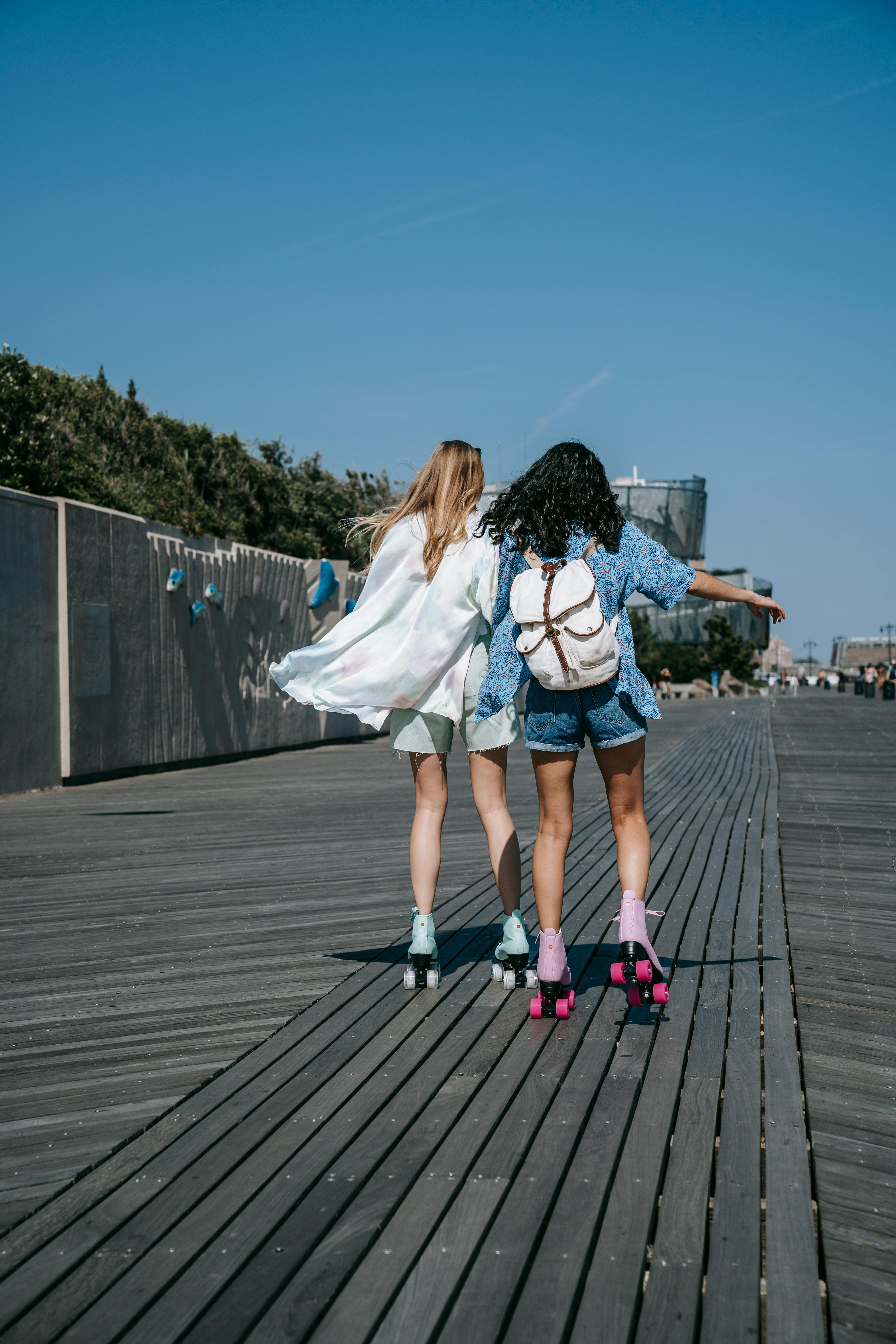Selective Focus Photo of Two Women in Roller Skates Leaning on a ...