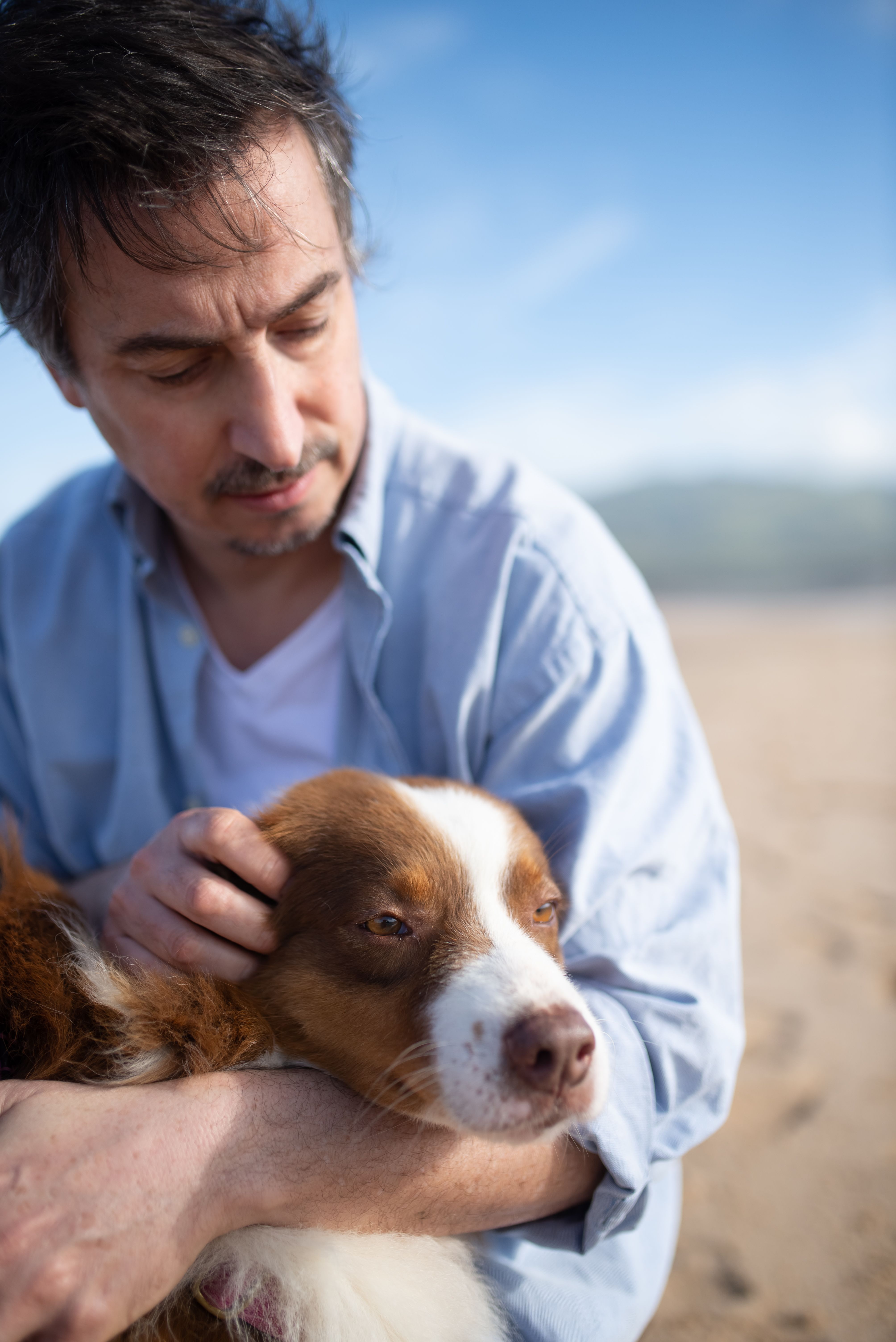 Man Carrying his Dog · Free Stock Photo