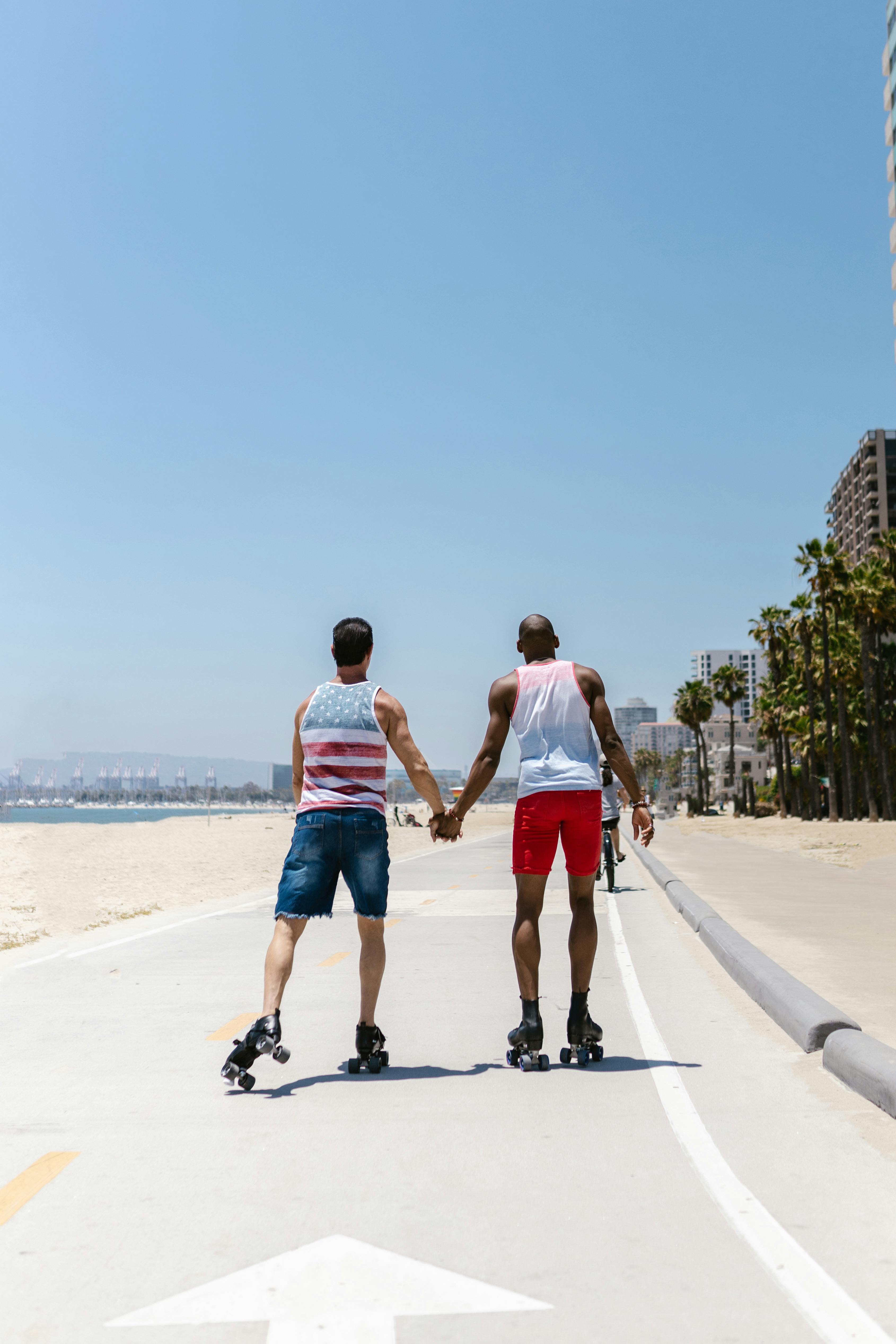 Photo of Men Roller Skating While Holding Hands · Free Stock Photo