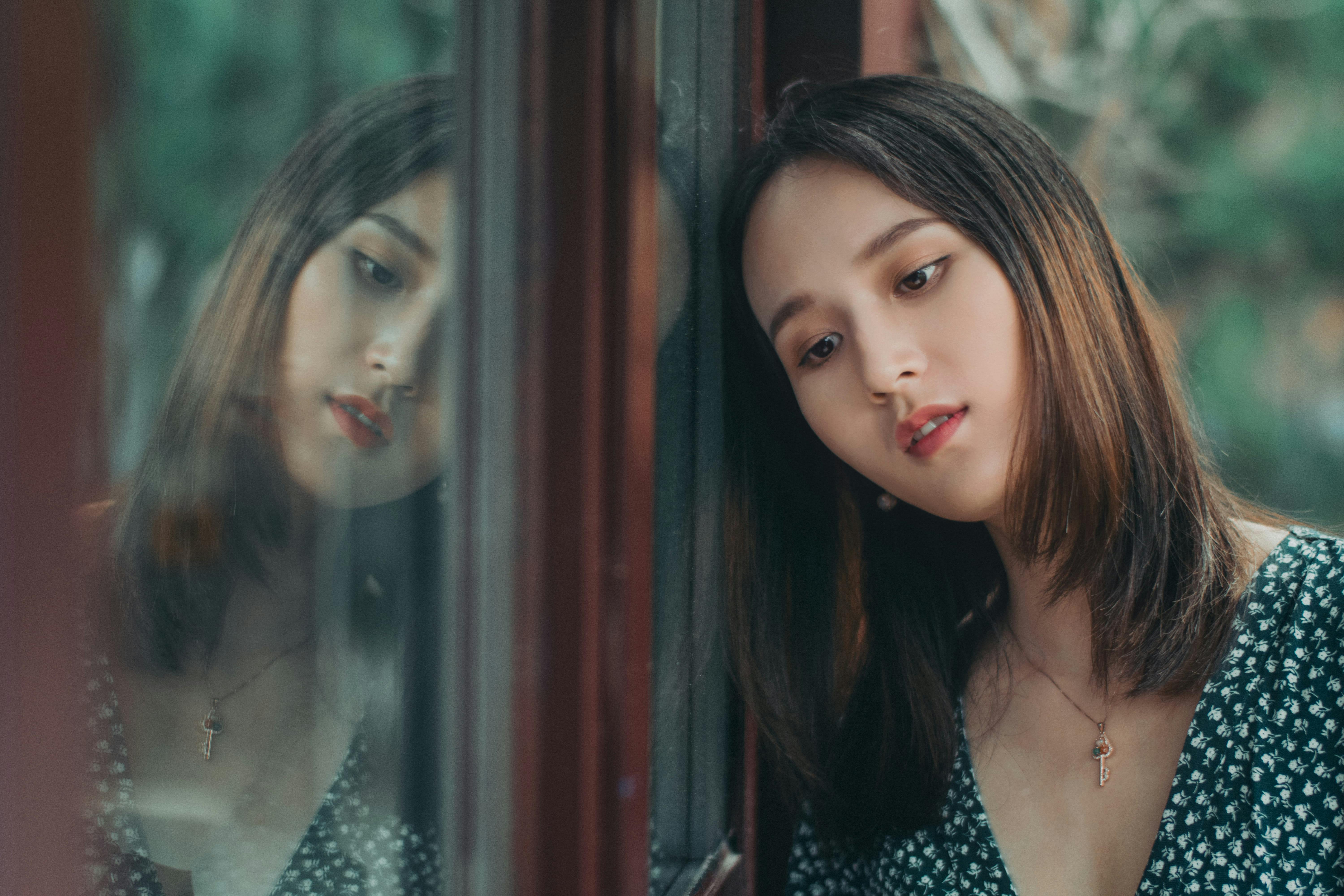 Woman Leaning on Glass Window · Free Stock Photo