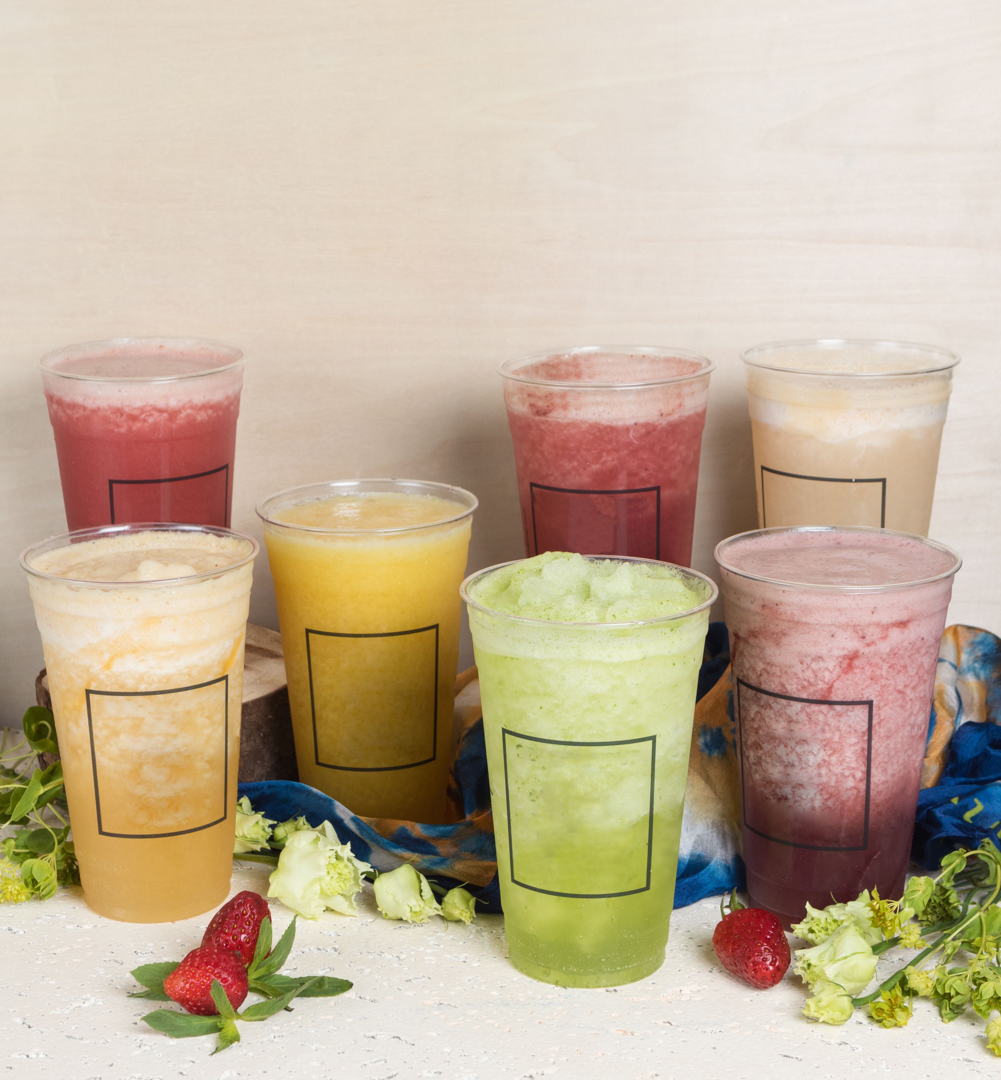 Disposable Plastic Cups of Milkshake on Green Grass · Free Stock Photo