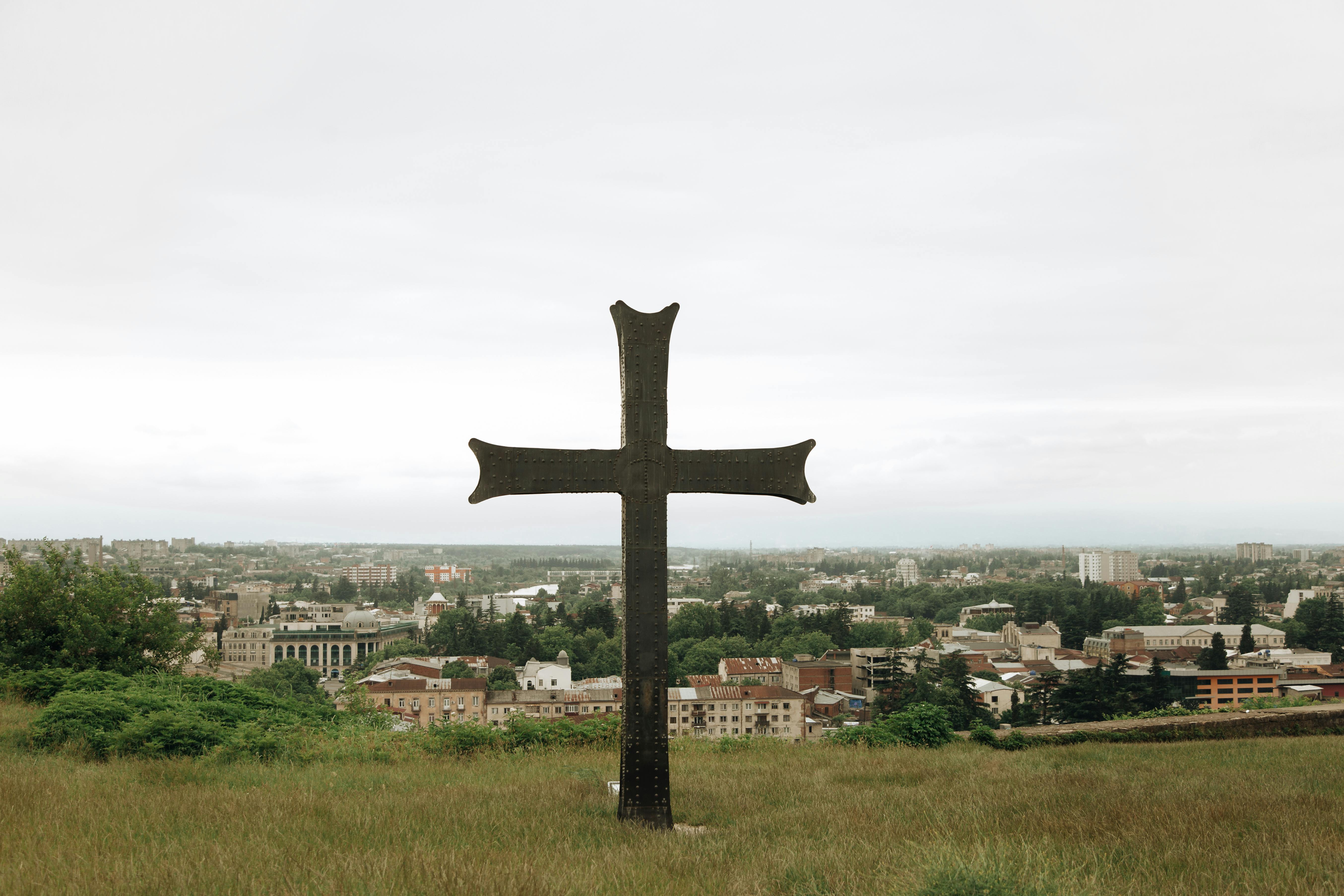Cross on Hill over Town · Free Stock Photo