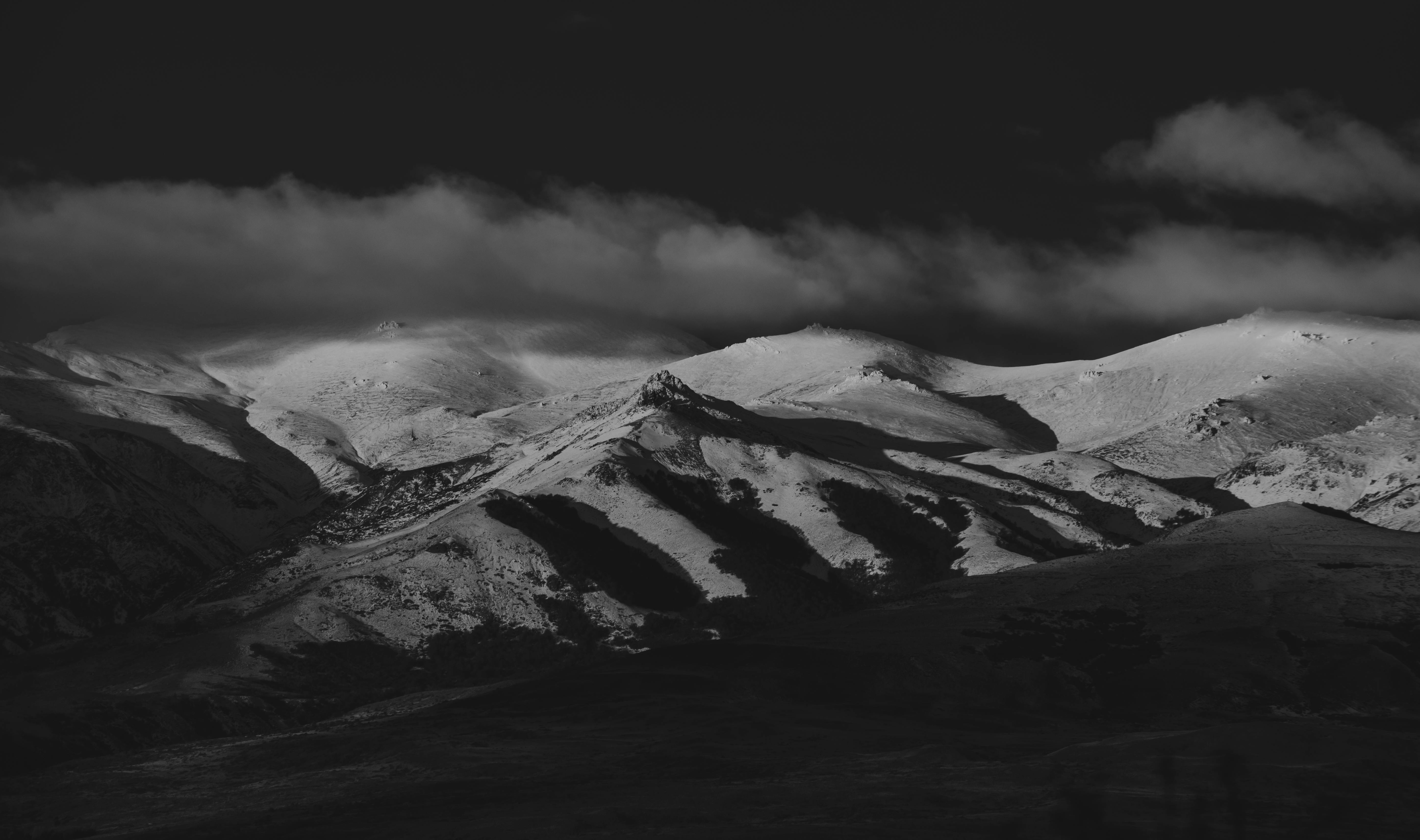 Grayscale Photography of Snow Covered Mountain Range · Free Stock Photo