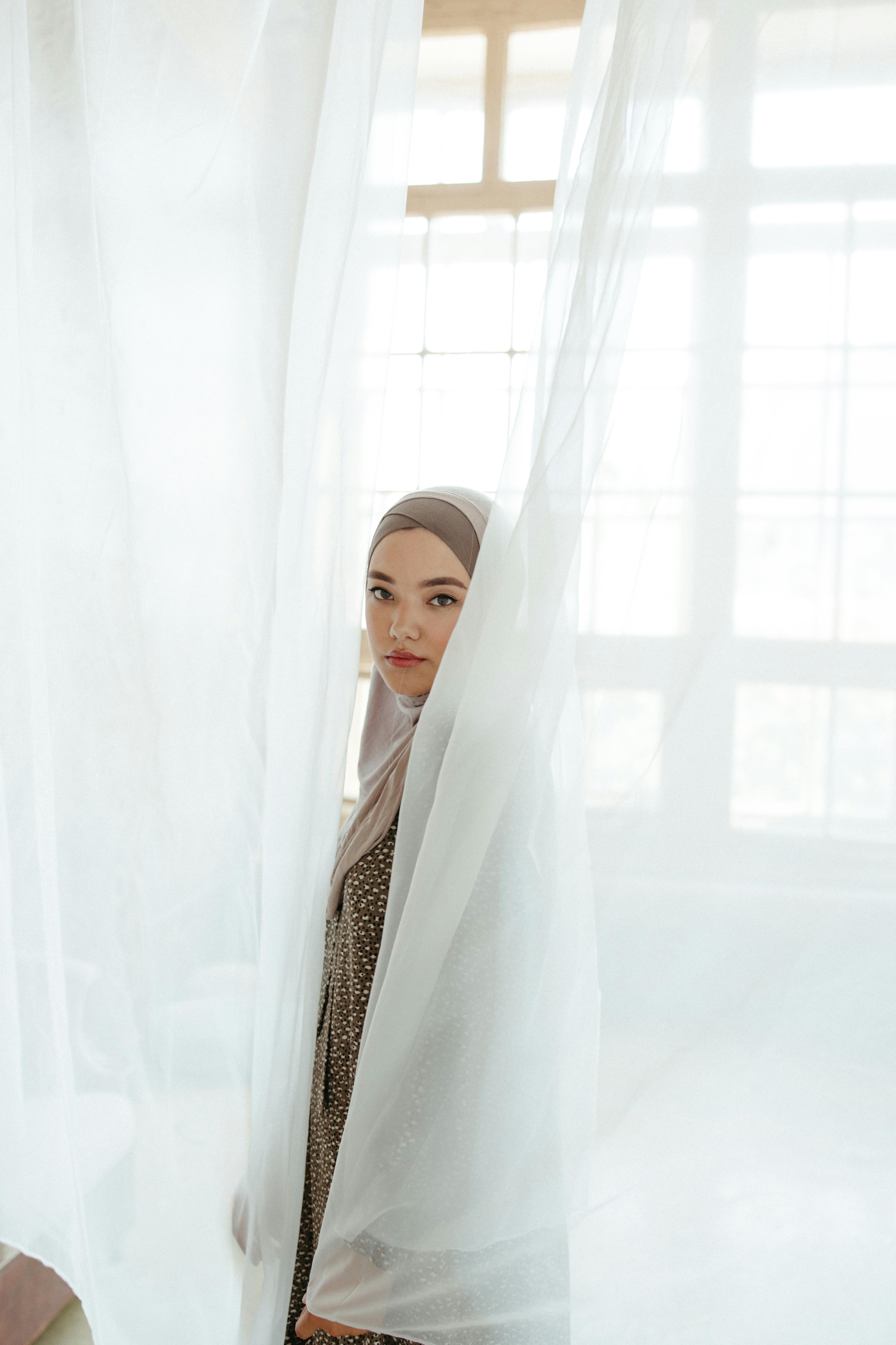 Woman Standing behind the White Curtains · Free Stock Photo