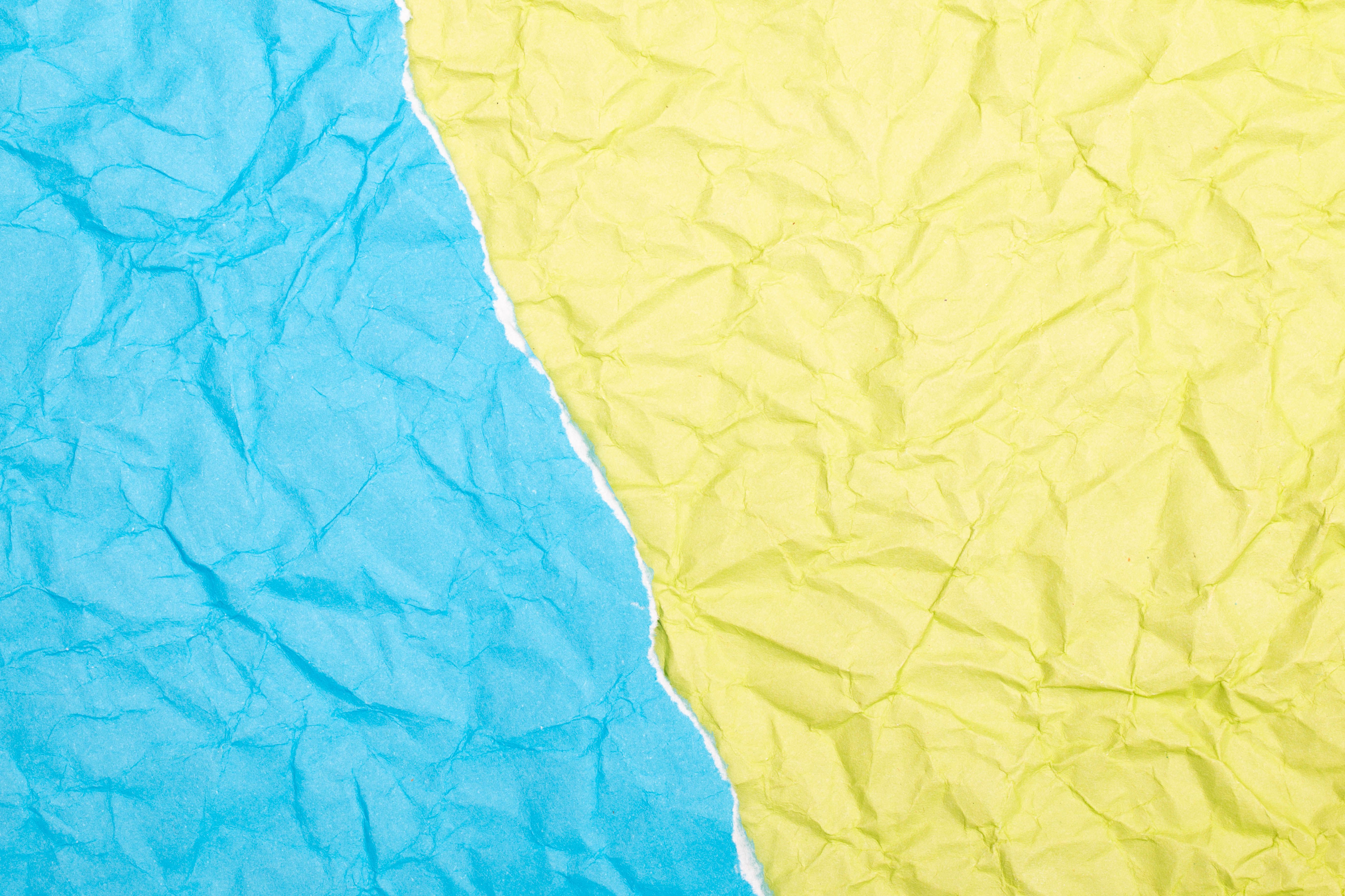 Close-Up Shot of Blue and Yellow Paper · Free Stock Photo