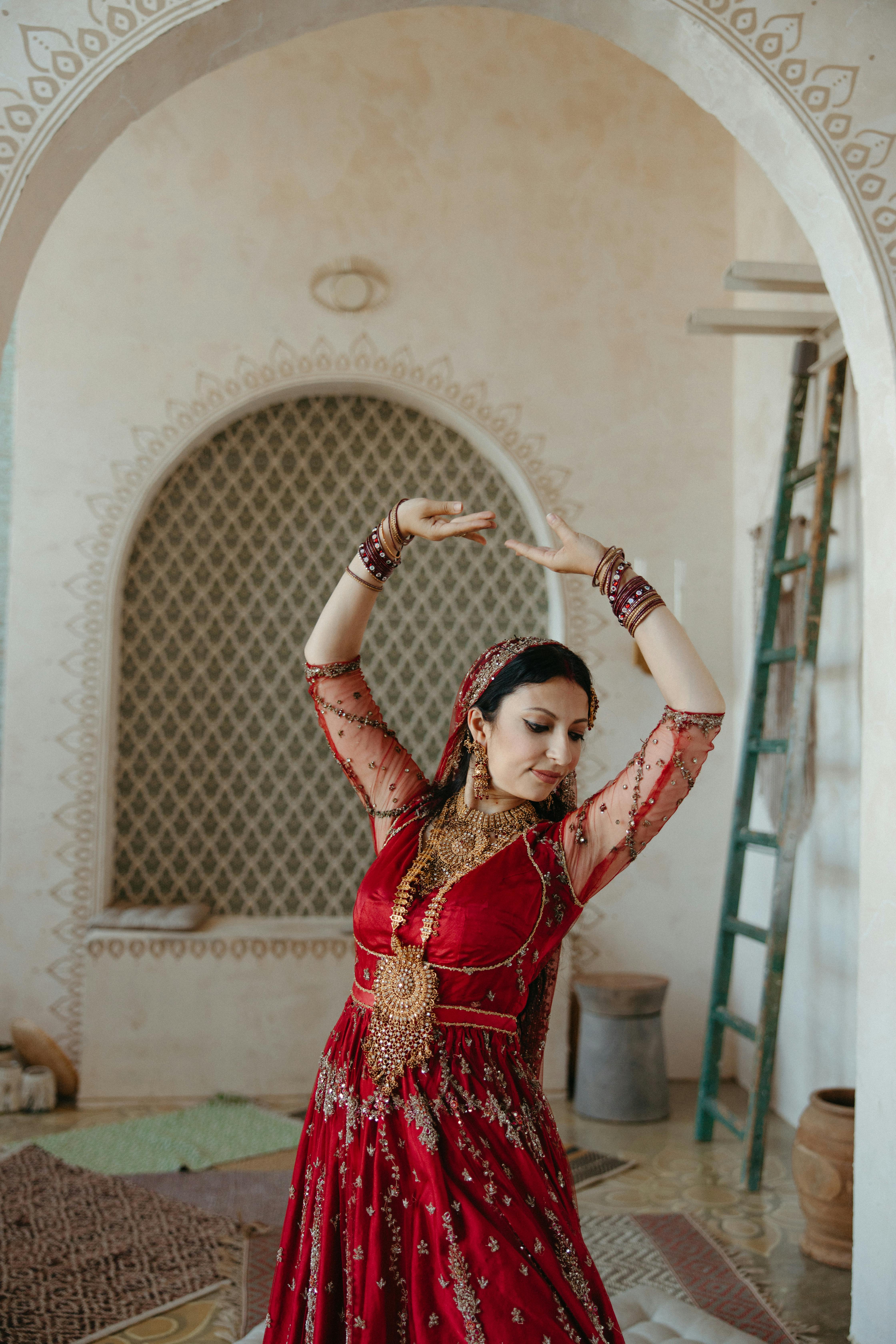 A Woman in Red Saree Dancing a Traditional Dance · Free Stock Photo