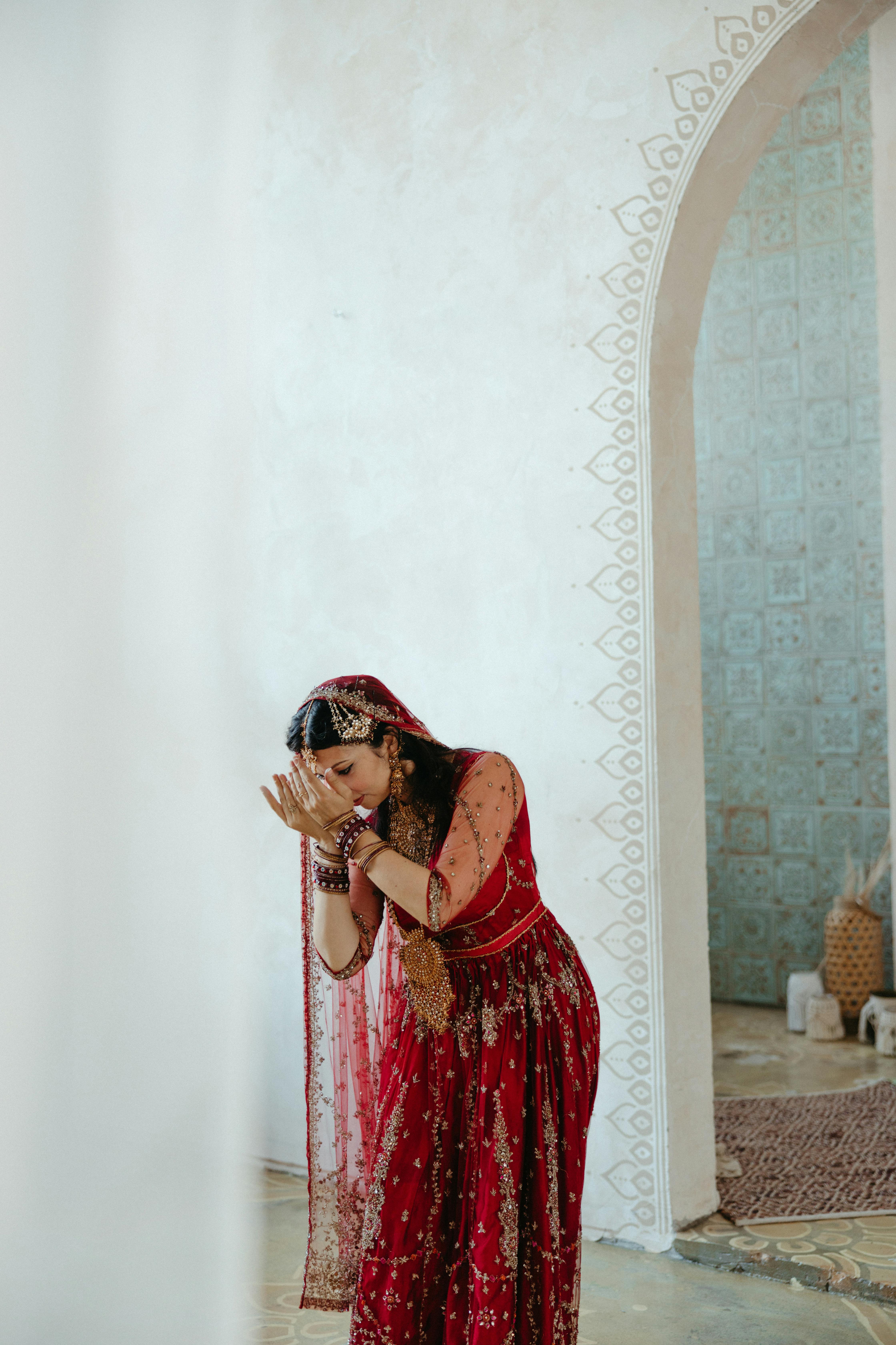 A Woman in Red Traditional Clothing Dancing Near the Doorway · Free ...