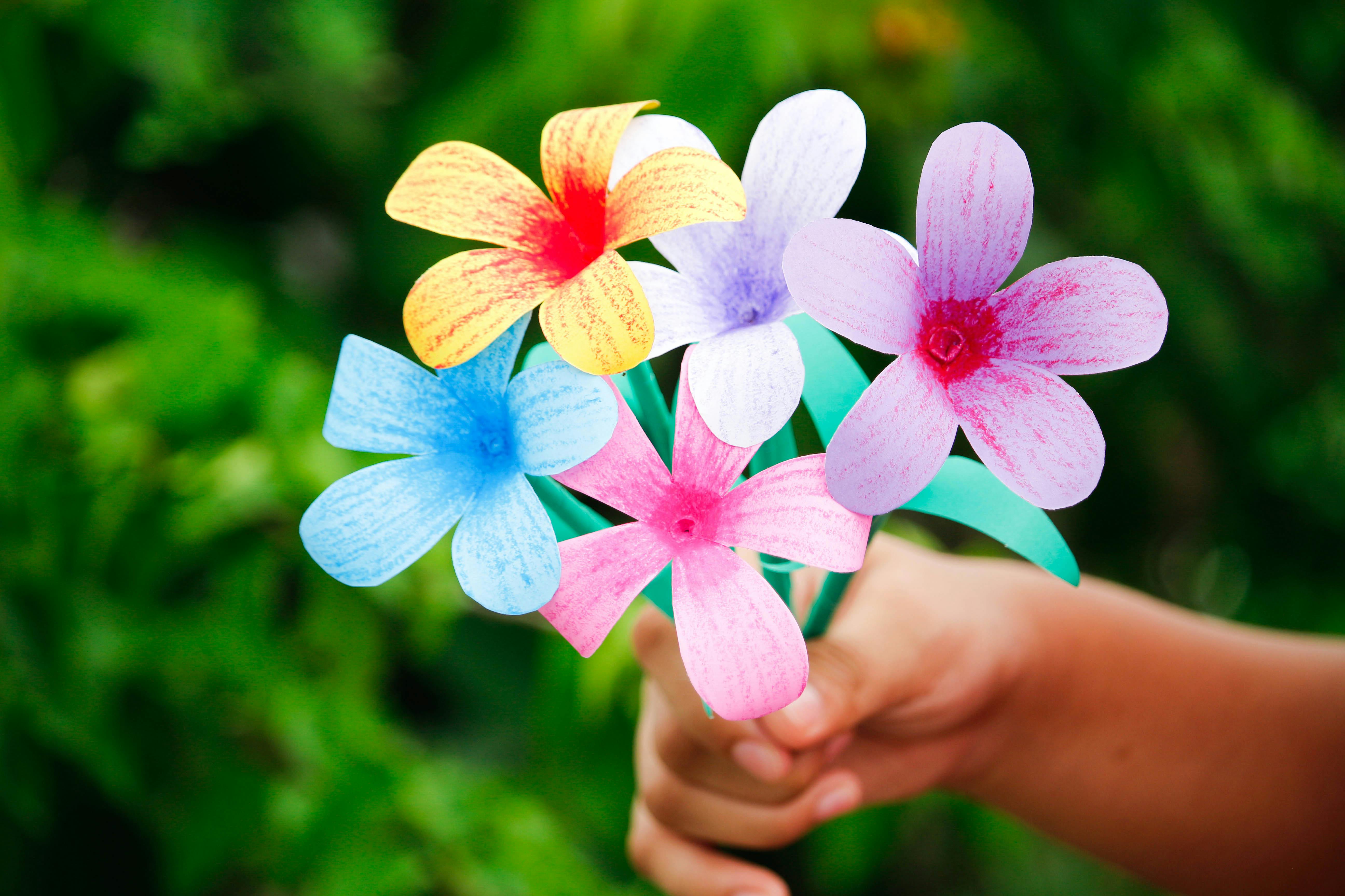 A Hand Holding Colorful Paper Flowers · Free Stock Photo
