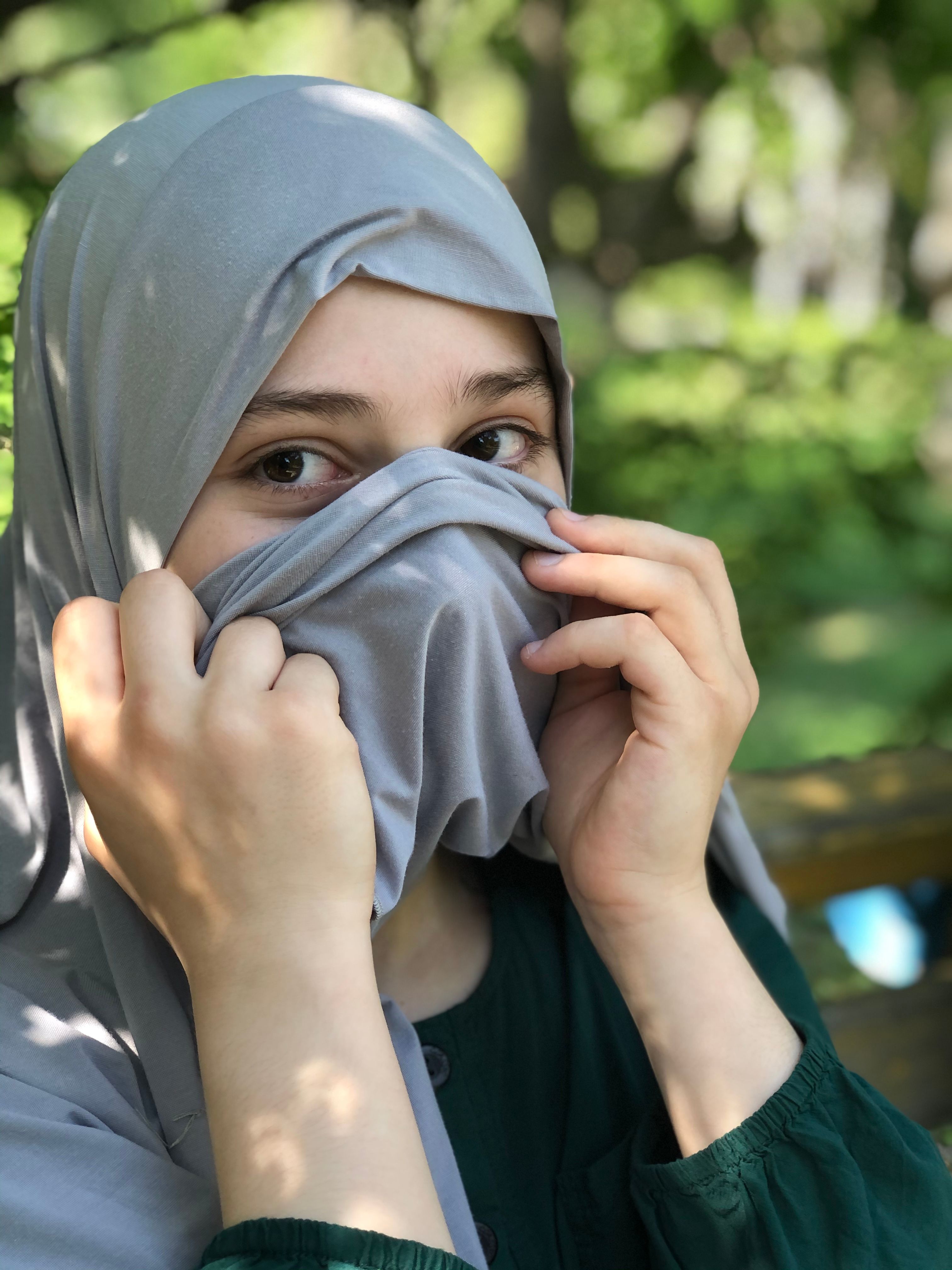Woman in Gray Hijab Covering Her Face · Free Stock Photo