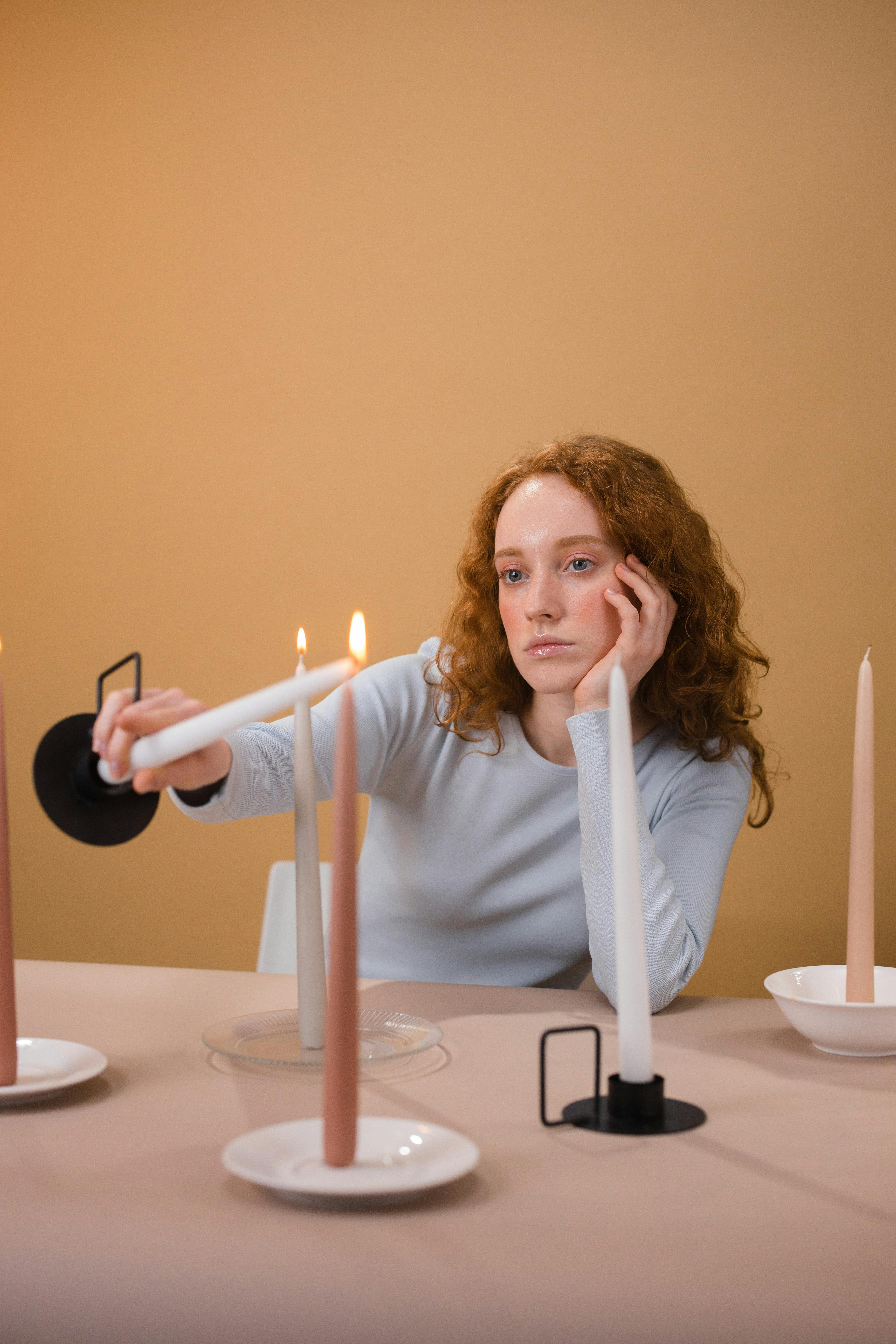 Person Holding Lighted White Candle in a Jar · Free Stock Photo
