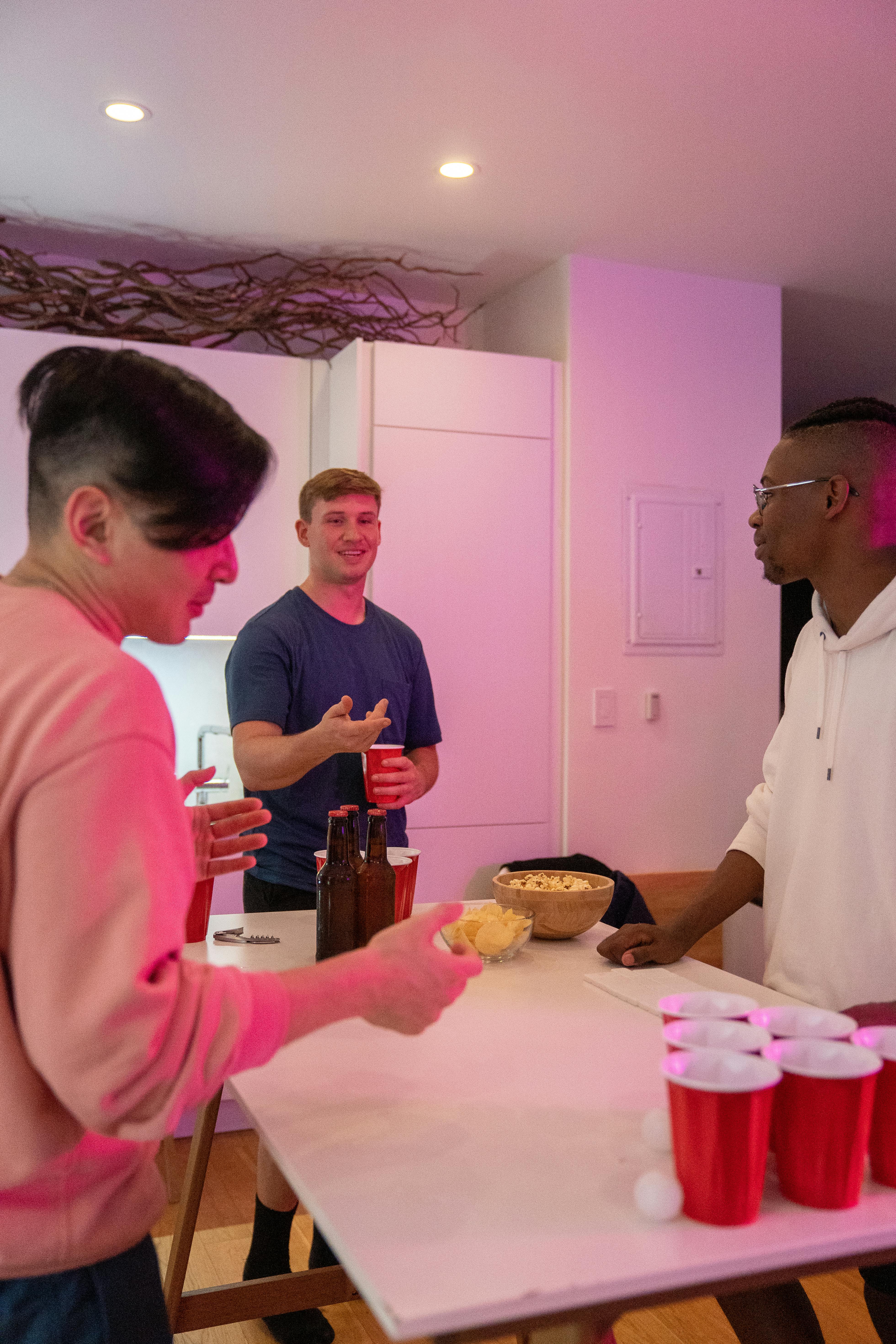Men Having a Conversation while Standing Beside the Table · Free Stock ...