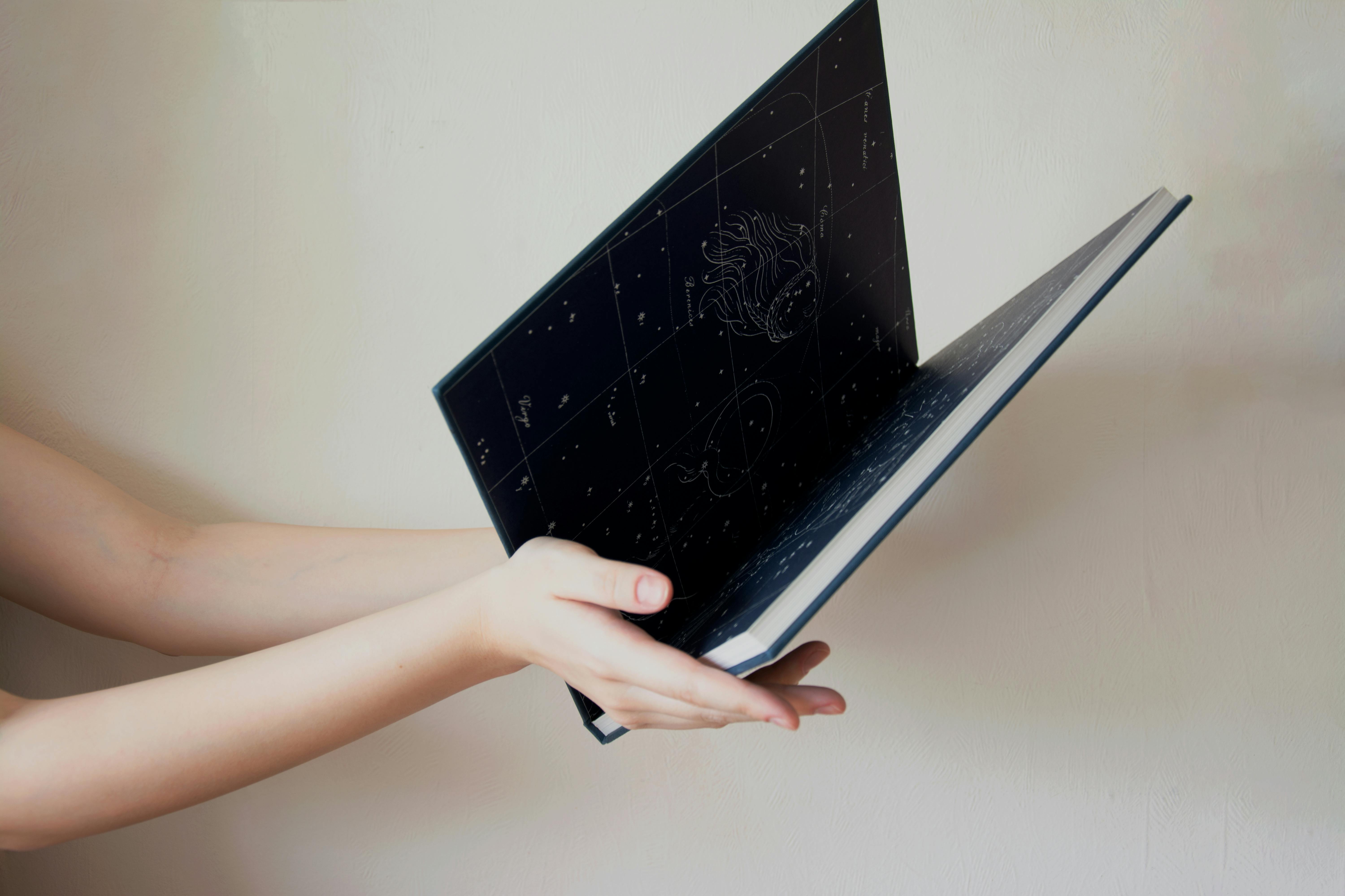 Hands Holding a Book · Free Stock Photo
