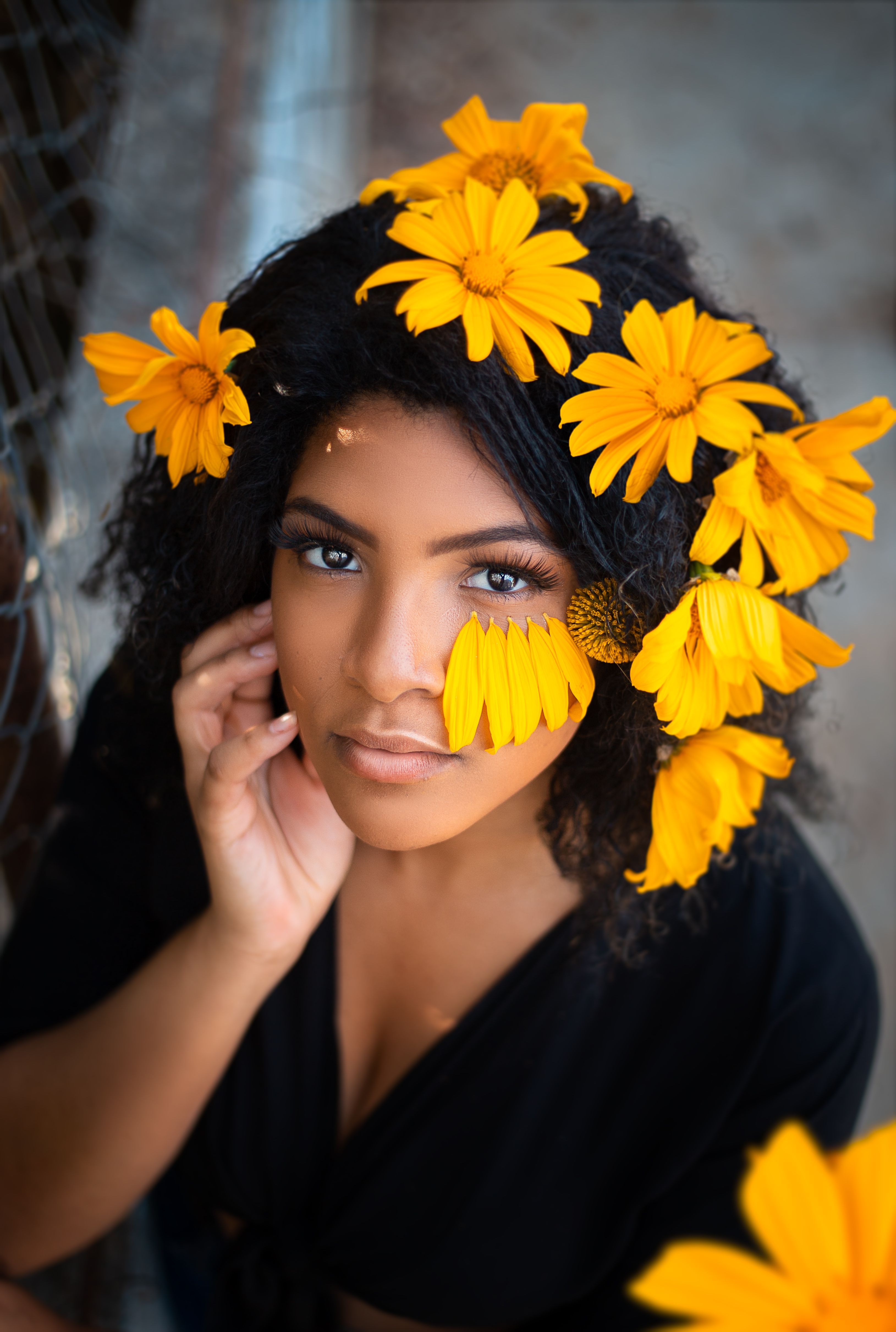 A Woman with Yellow Flowers on Hair and Petals on Face · Free Stock Photo
