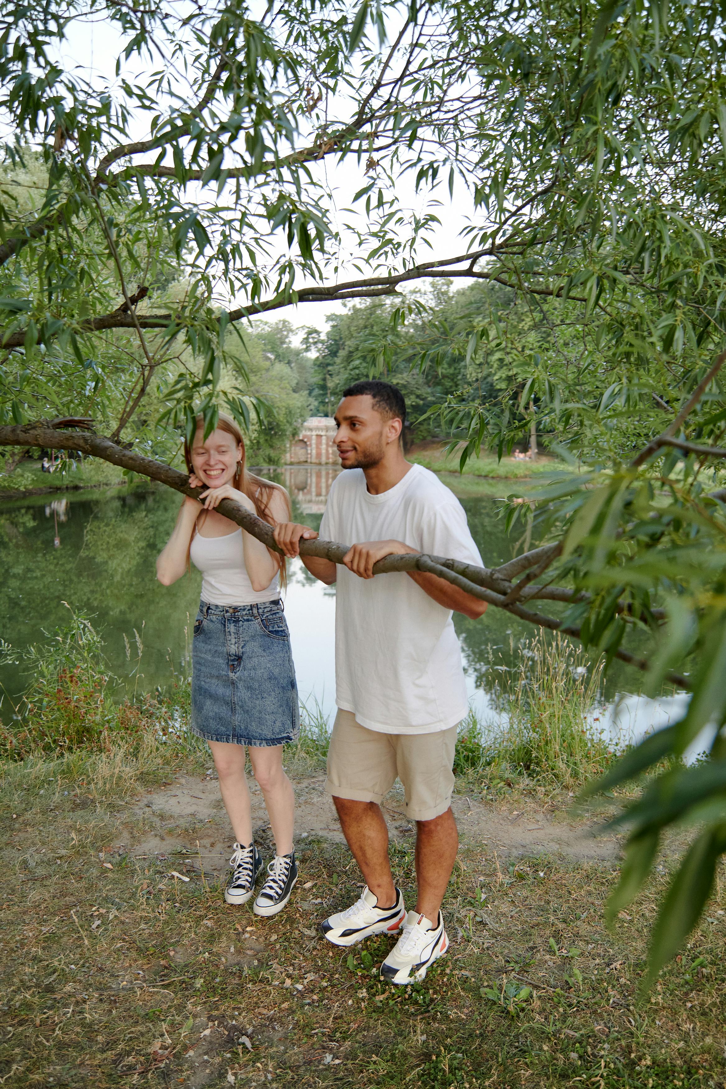 A Man and a Woman Standing Beside Each Other Near Green Tree · Free ...