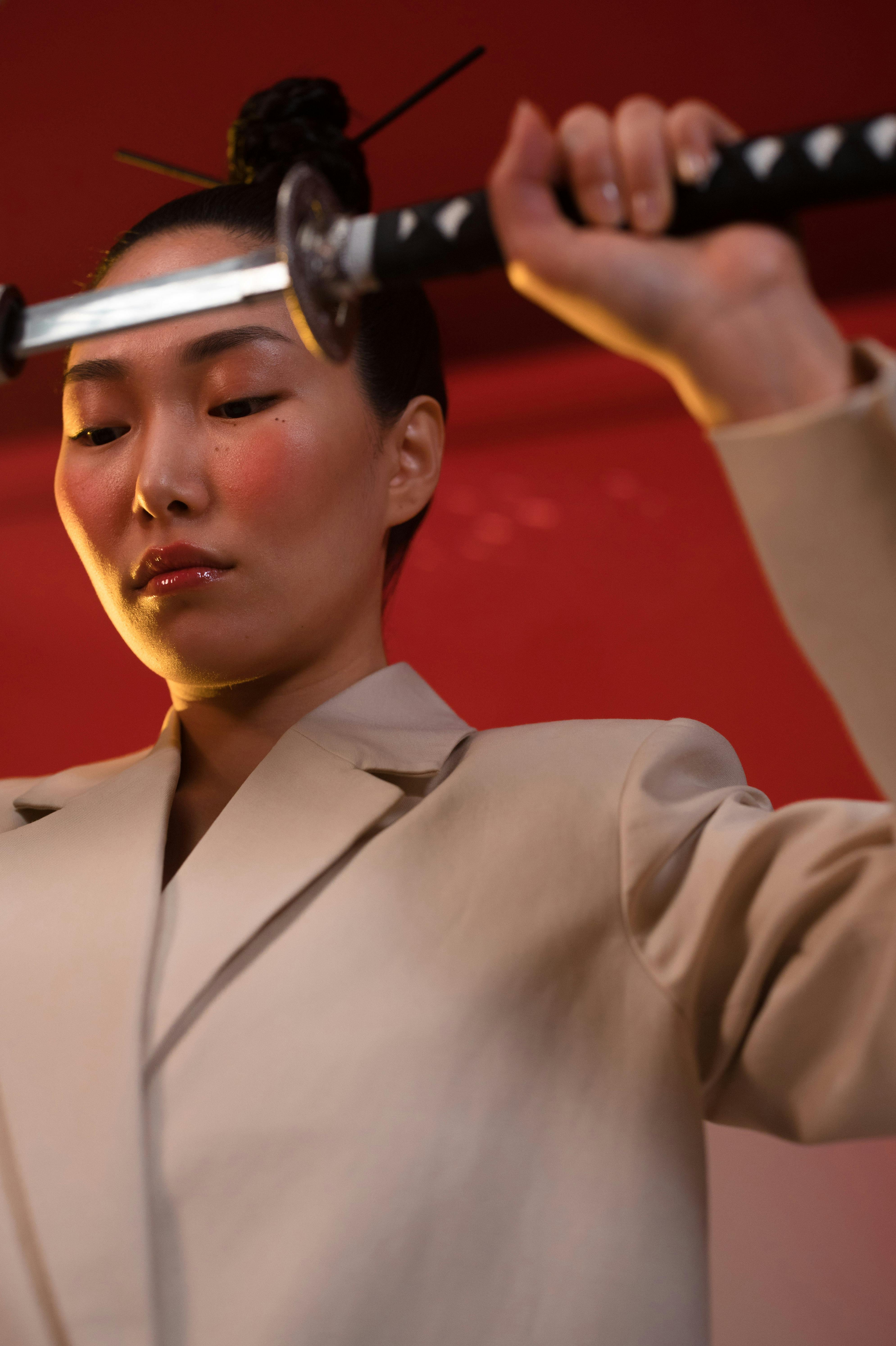 A Woman in a Blazer Holding Sword · Free Stock Photo