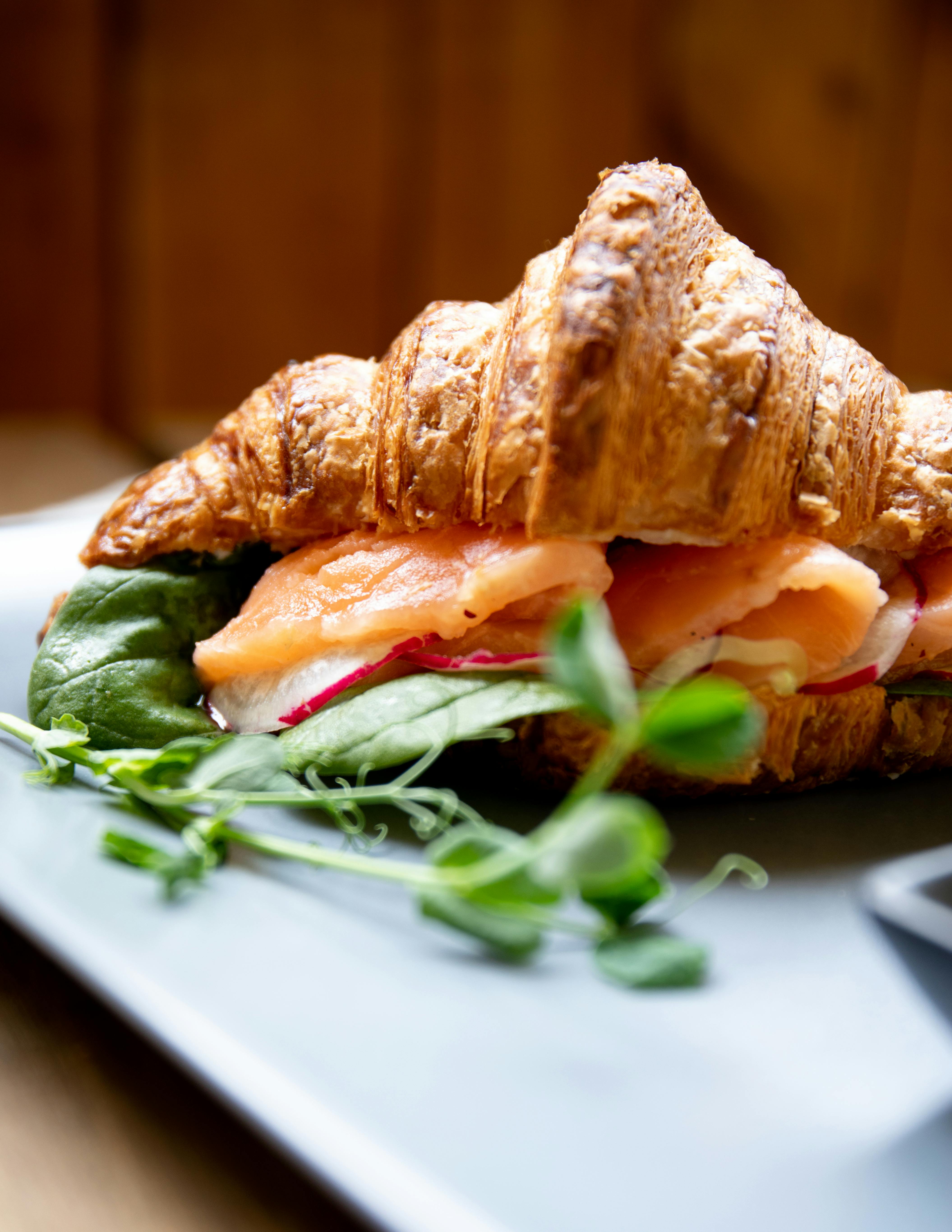 Close Up of Croissant Sandwich on a Plate · Free Stock Photo