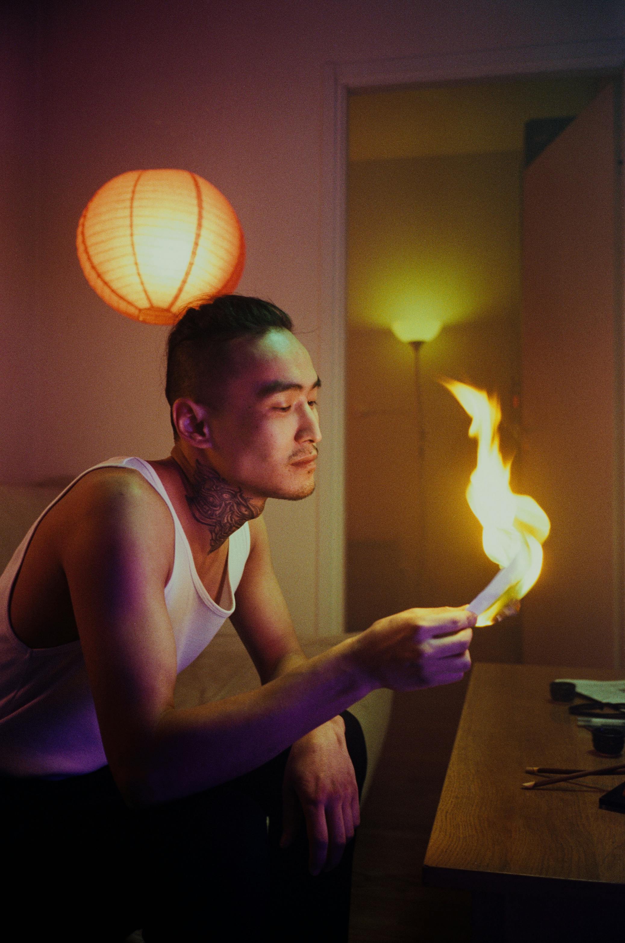 Person Holding a Burning Paper · Free Stock Photo