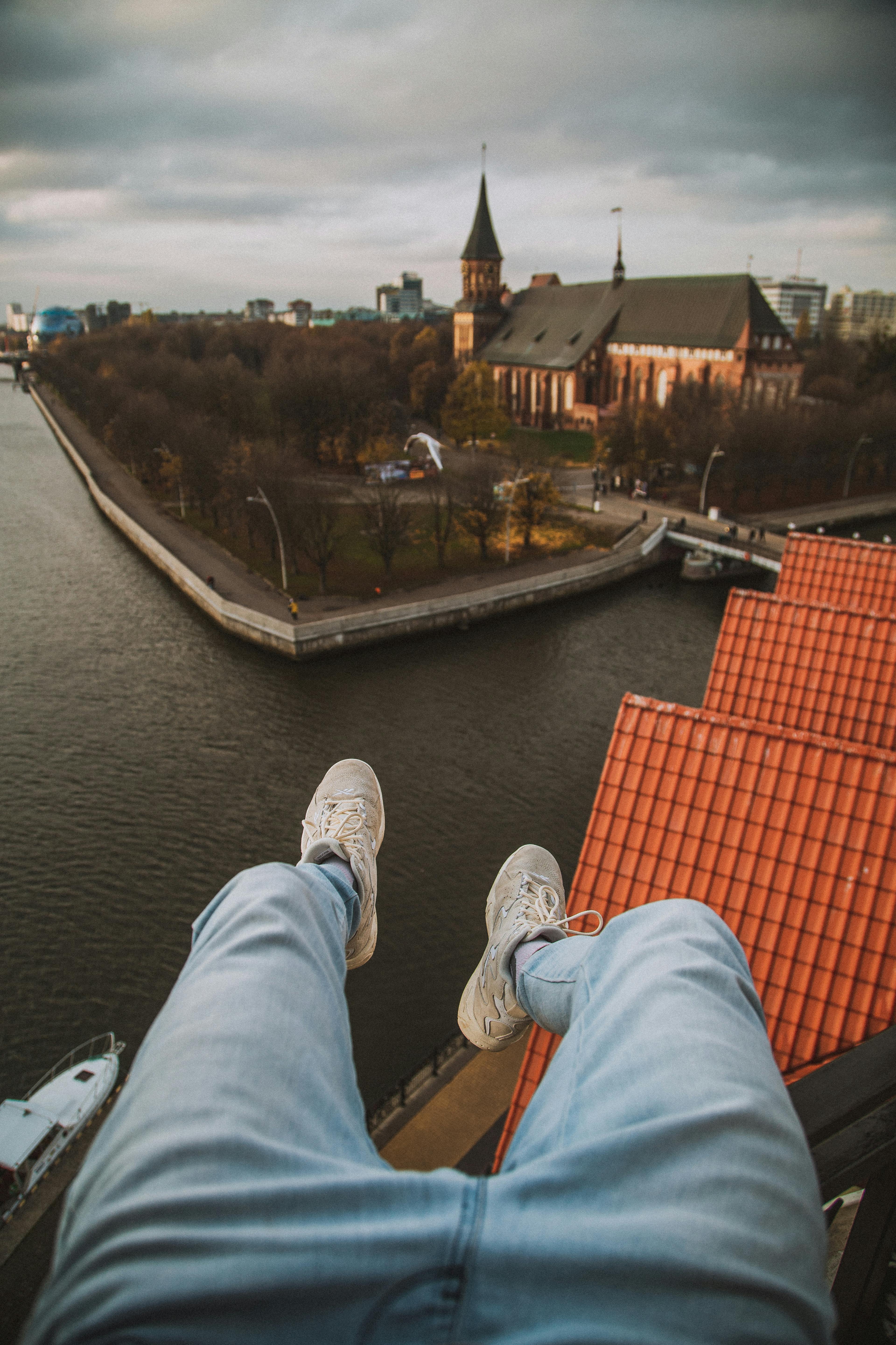 Person standing on Roof with River View · Free Stock Photo