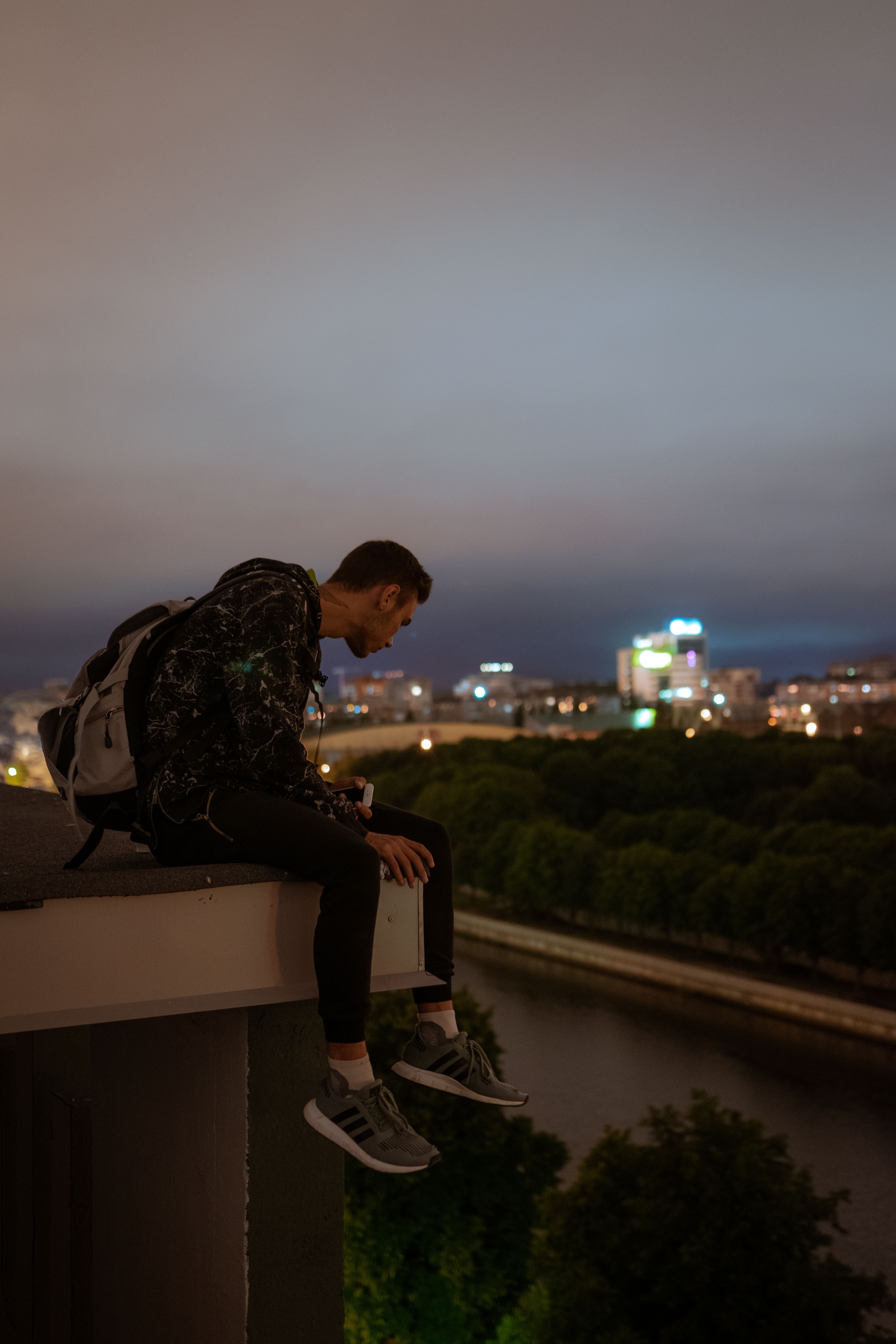 Man Sitting on the Edge of a Building · Free Stock Photo