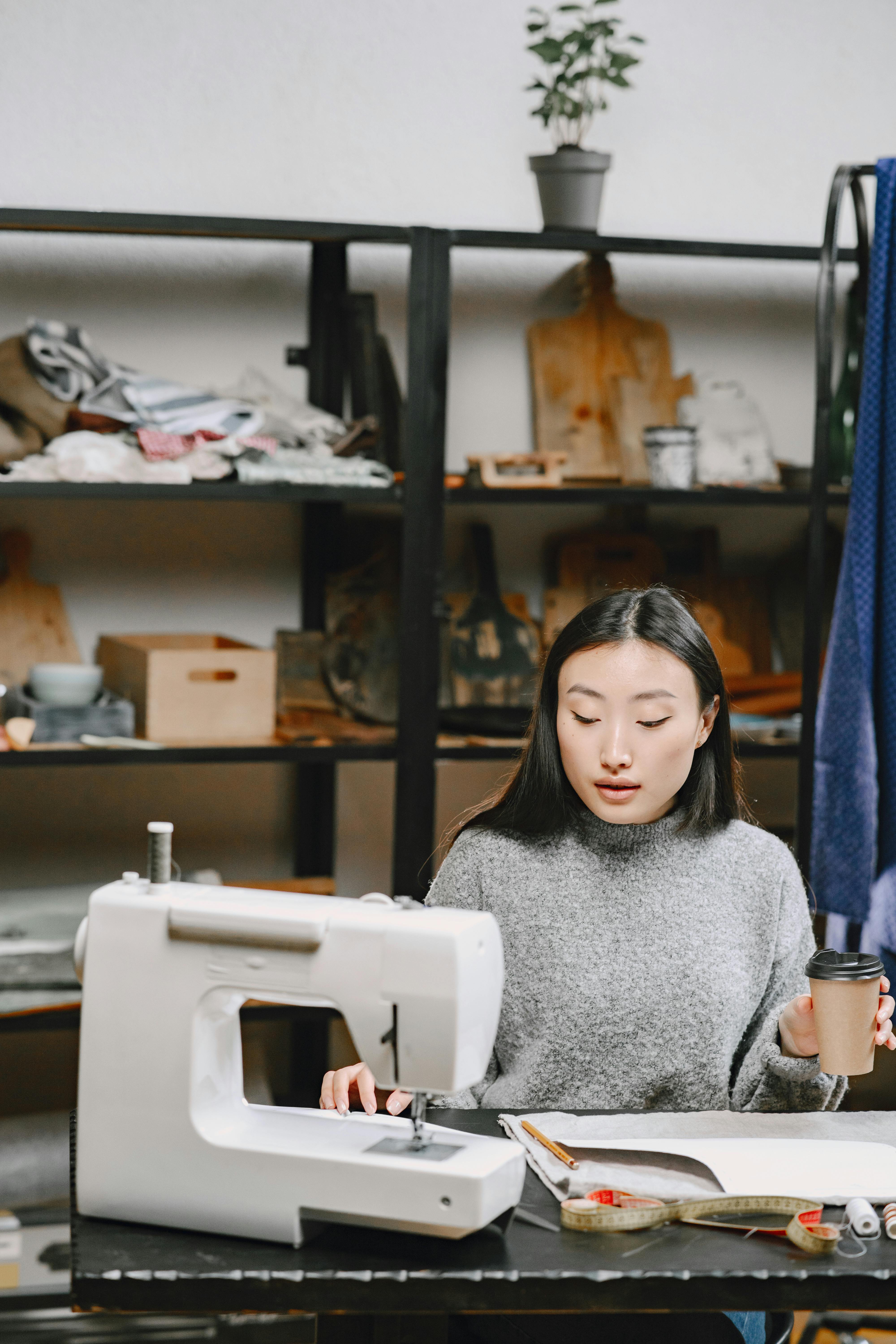 A Person Using a Sewing Machine · Free Stock Photo