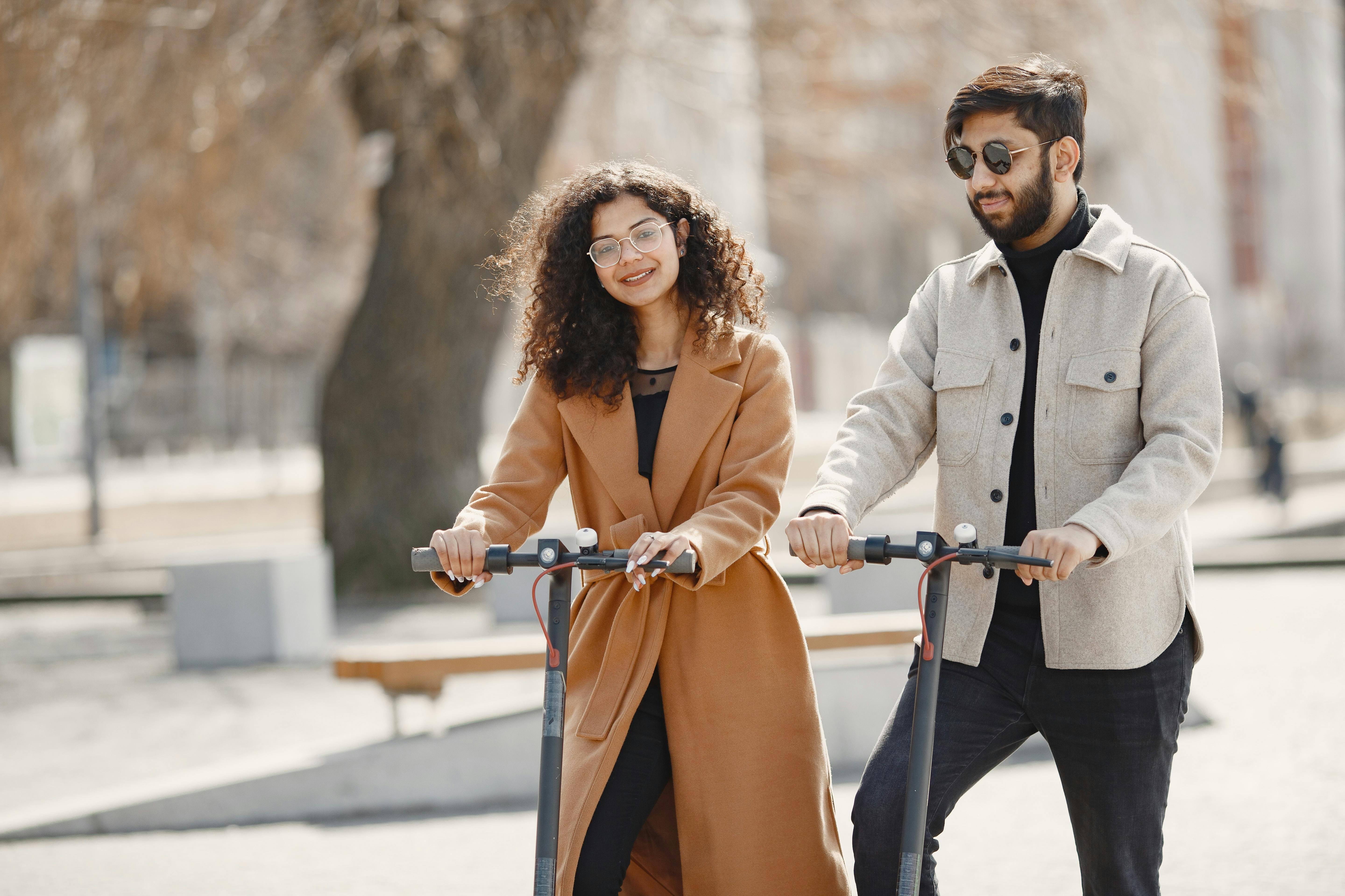 Couple riding Electric Scooters · Free Stock Photo