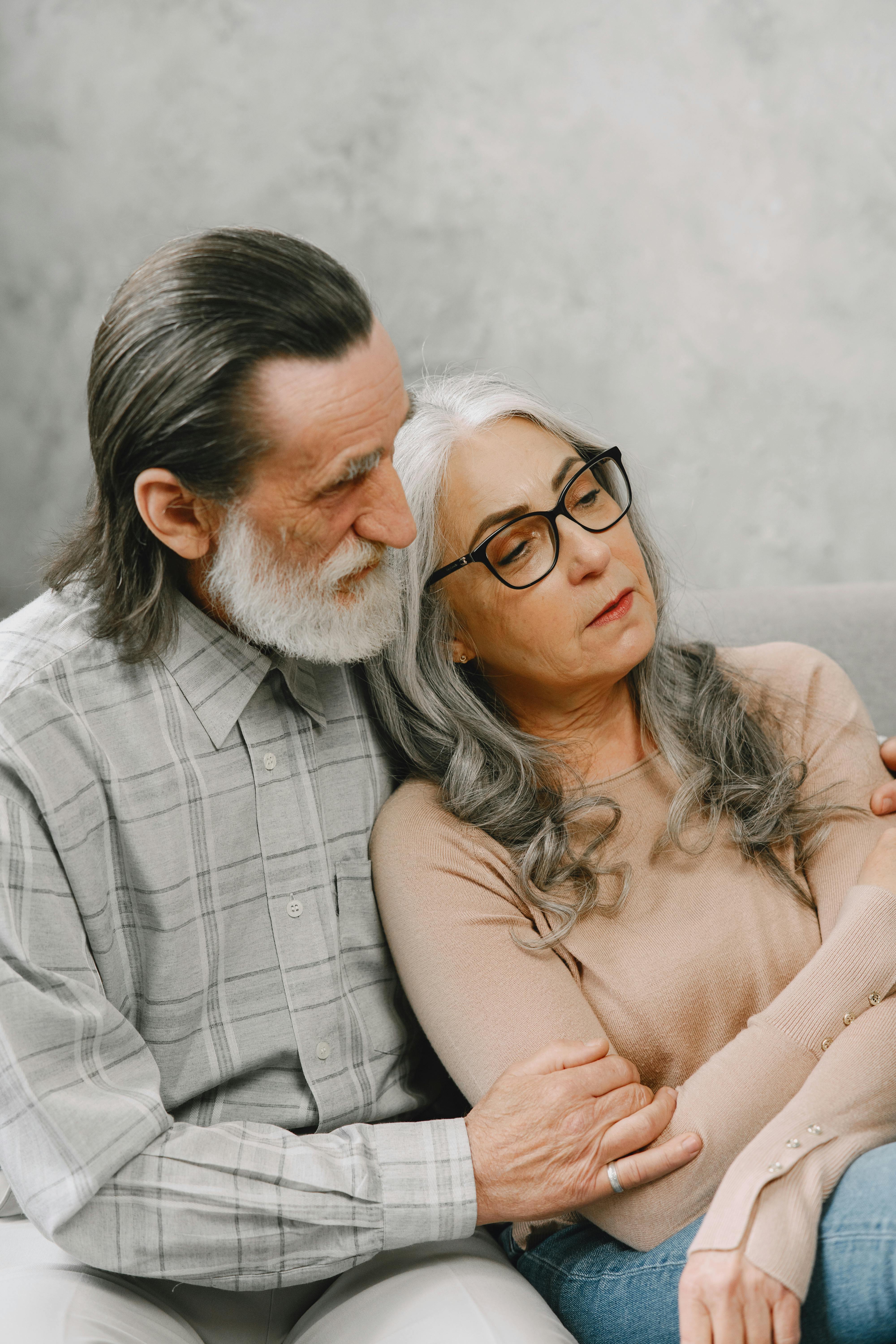 Man Embracing Woman While Sitting Down · Free Stock Photo