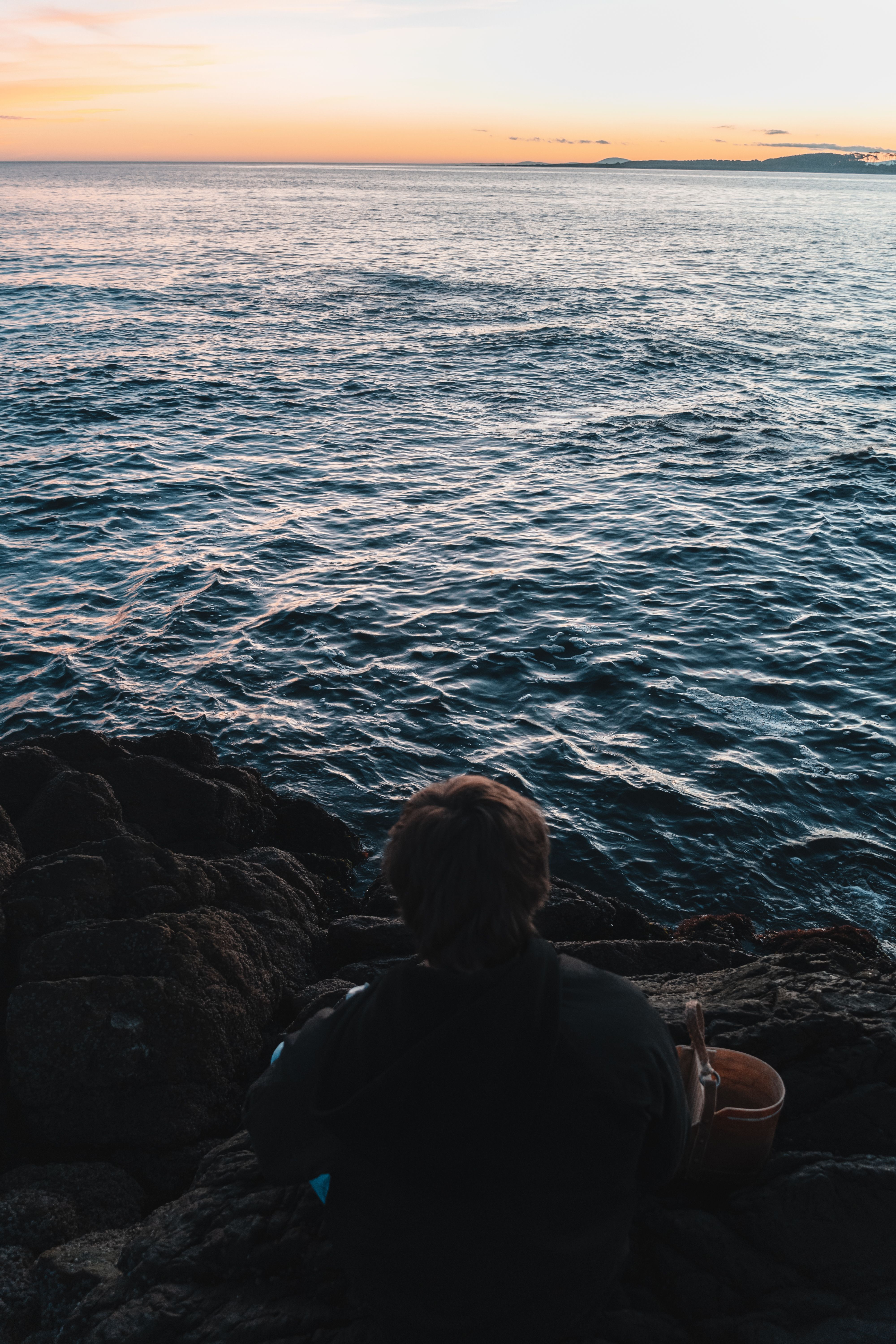 Photo of Person Sitting on Cliff · Free Stock Photo