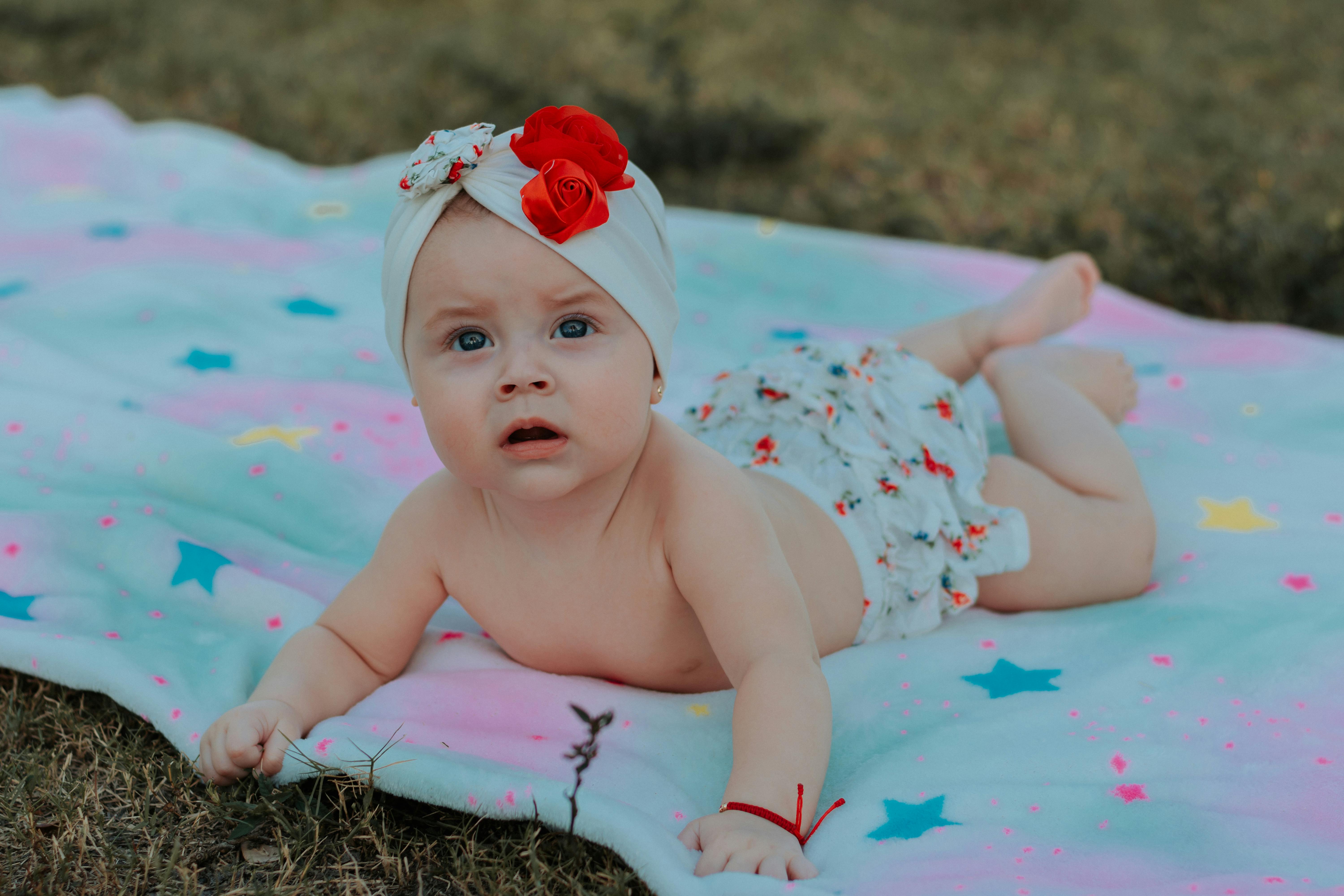 A Kid Squeezing the Face of a Baby · Free Stock Photo