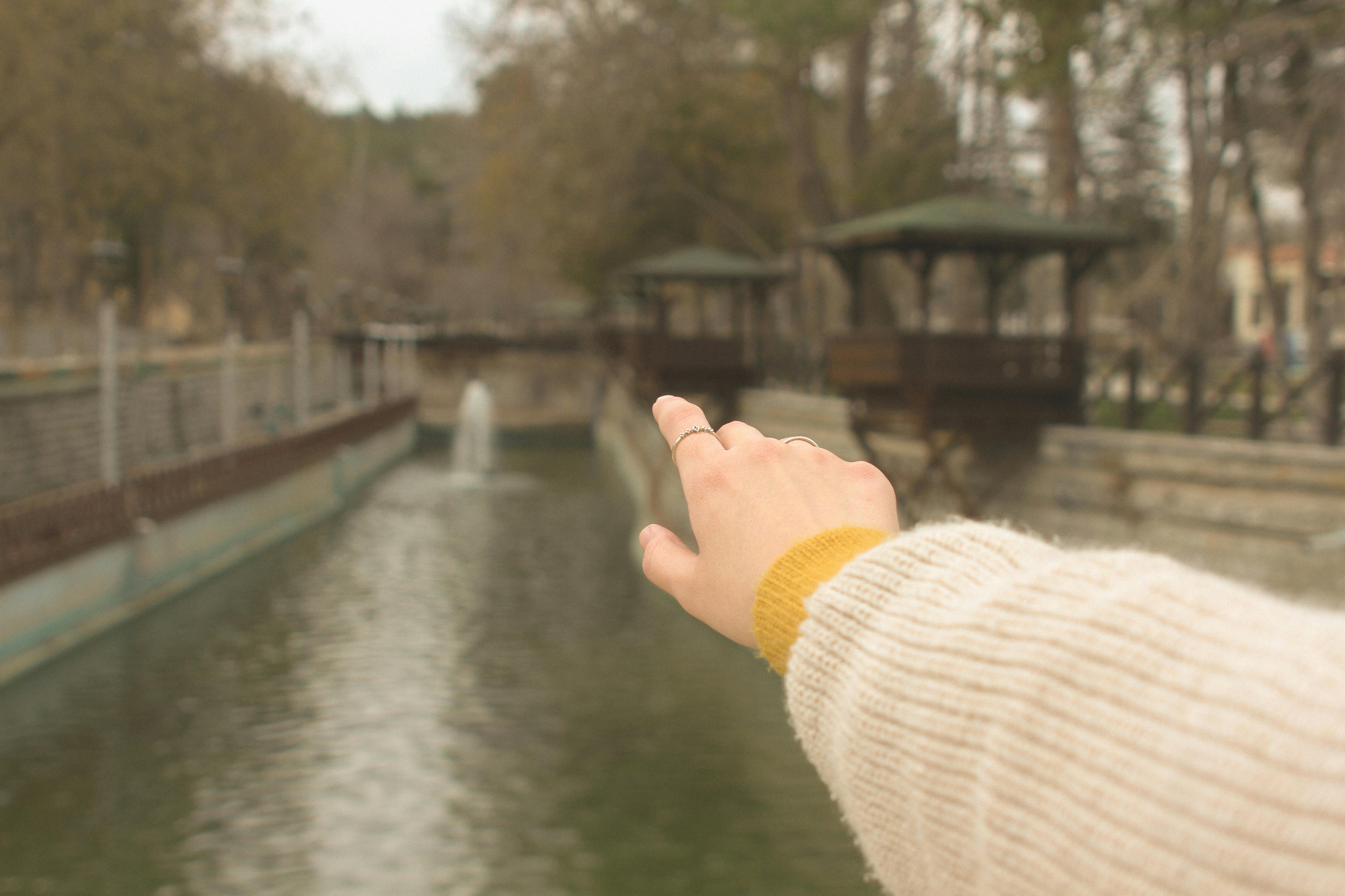 Woman Reaching Her Arm in the Direction of a River · Free Stock Photo