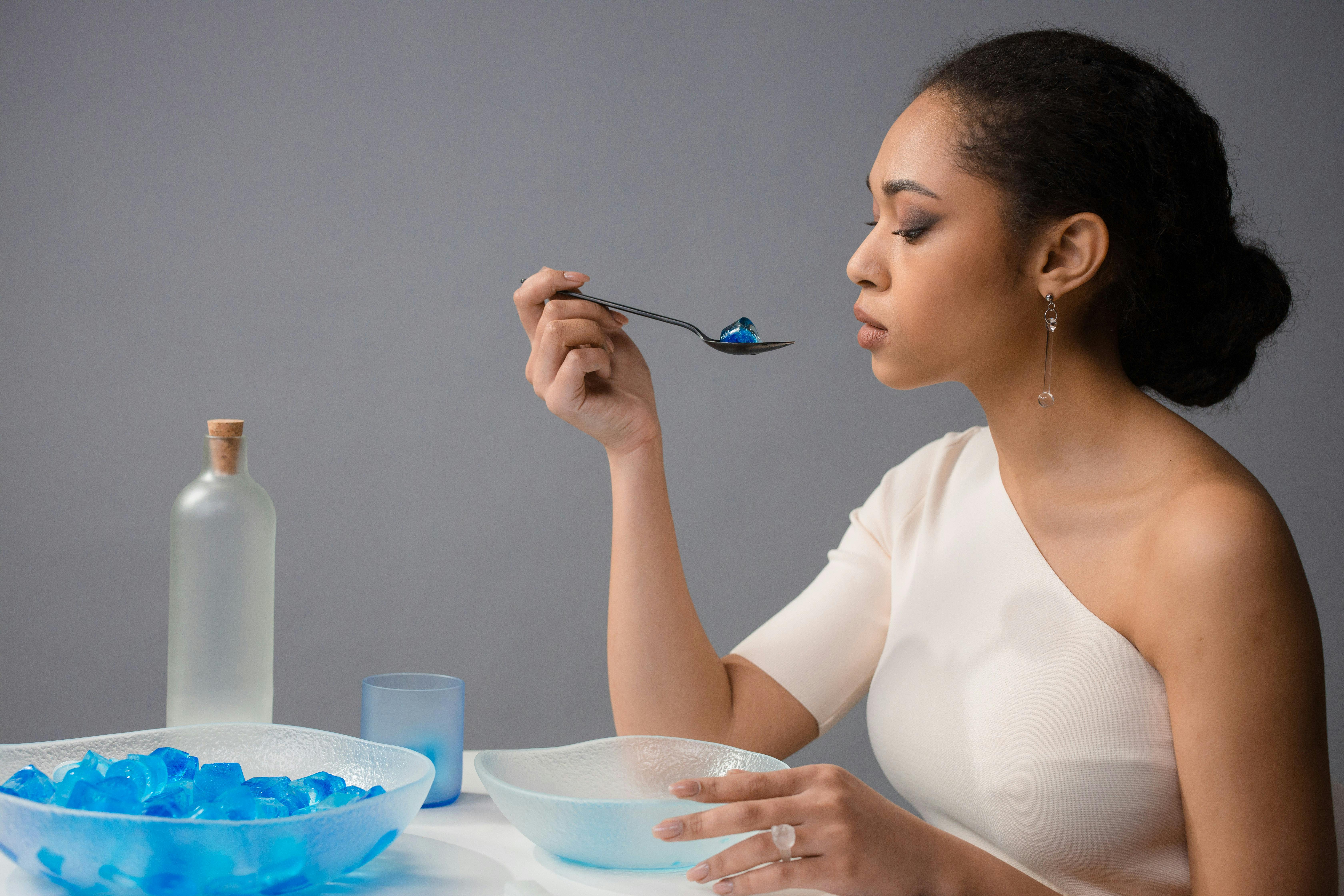 Woman in White Dress Holding Black Spoon · Free Stock Photo