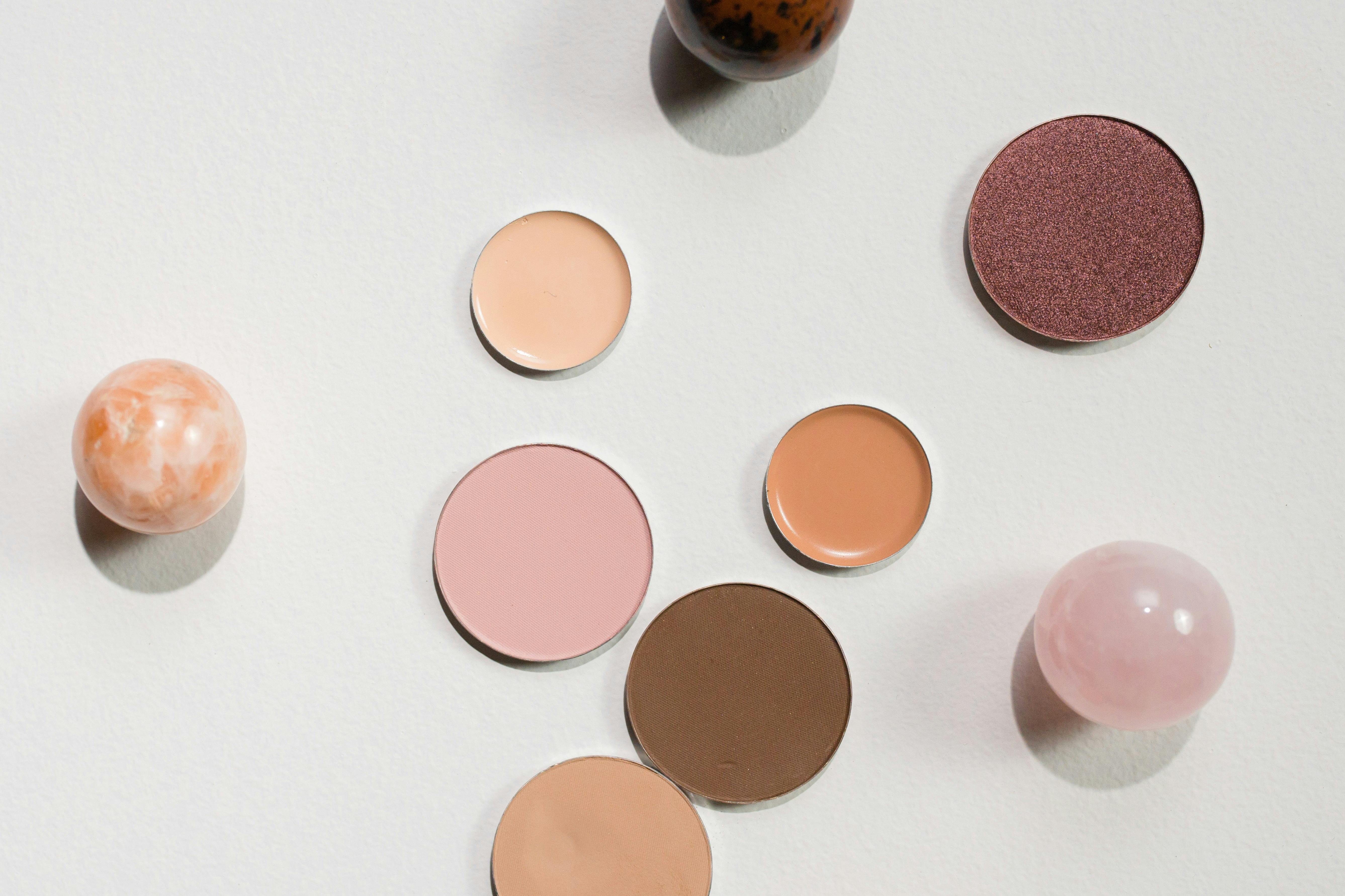 Close-Up Shot of Cosmetics on a White Surface · Free Stock Photo