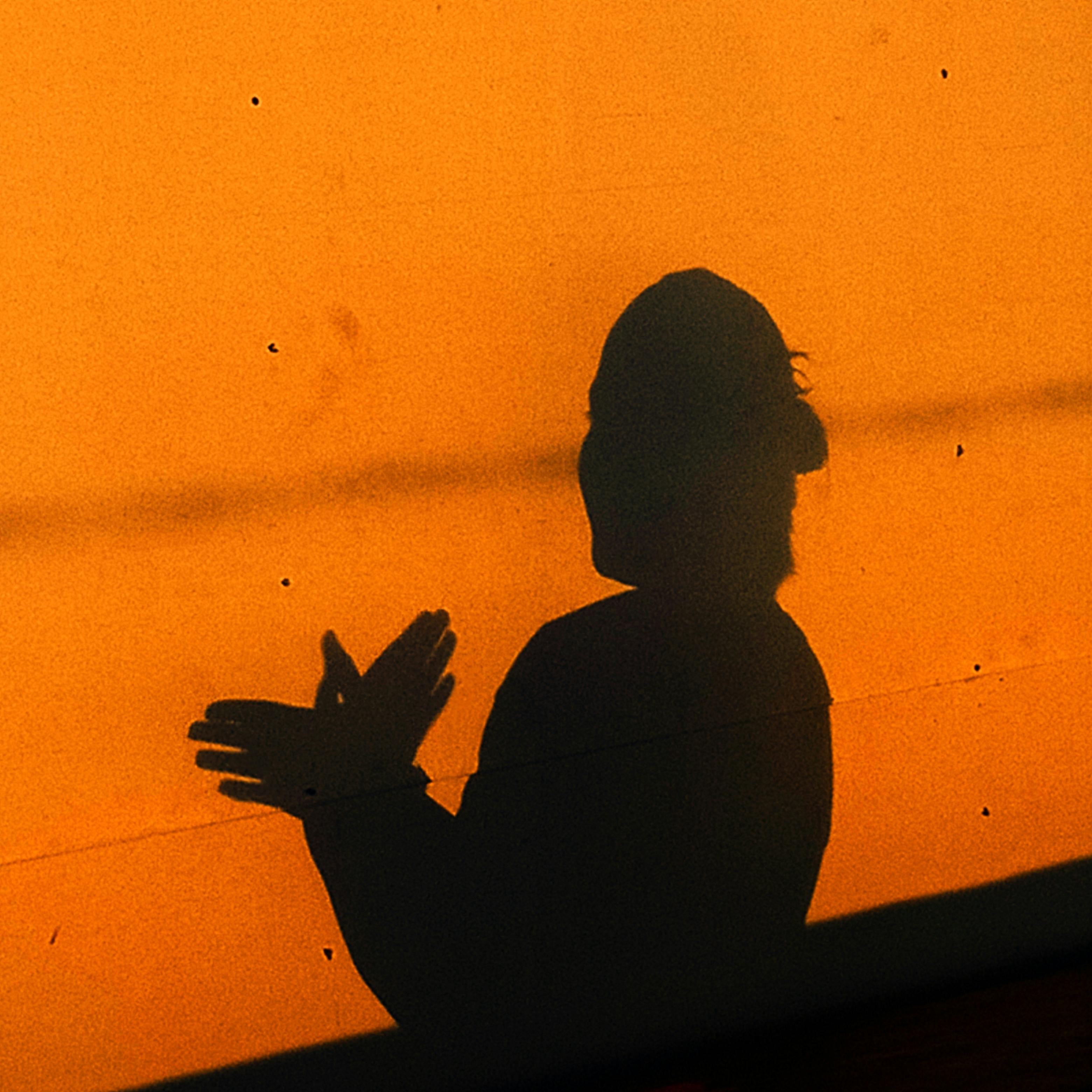 Shadow of Person Standing in Front of Orange Wall · Free Stock Photo