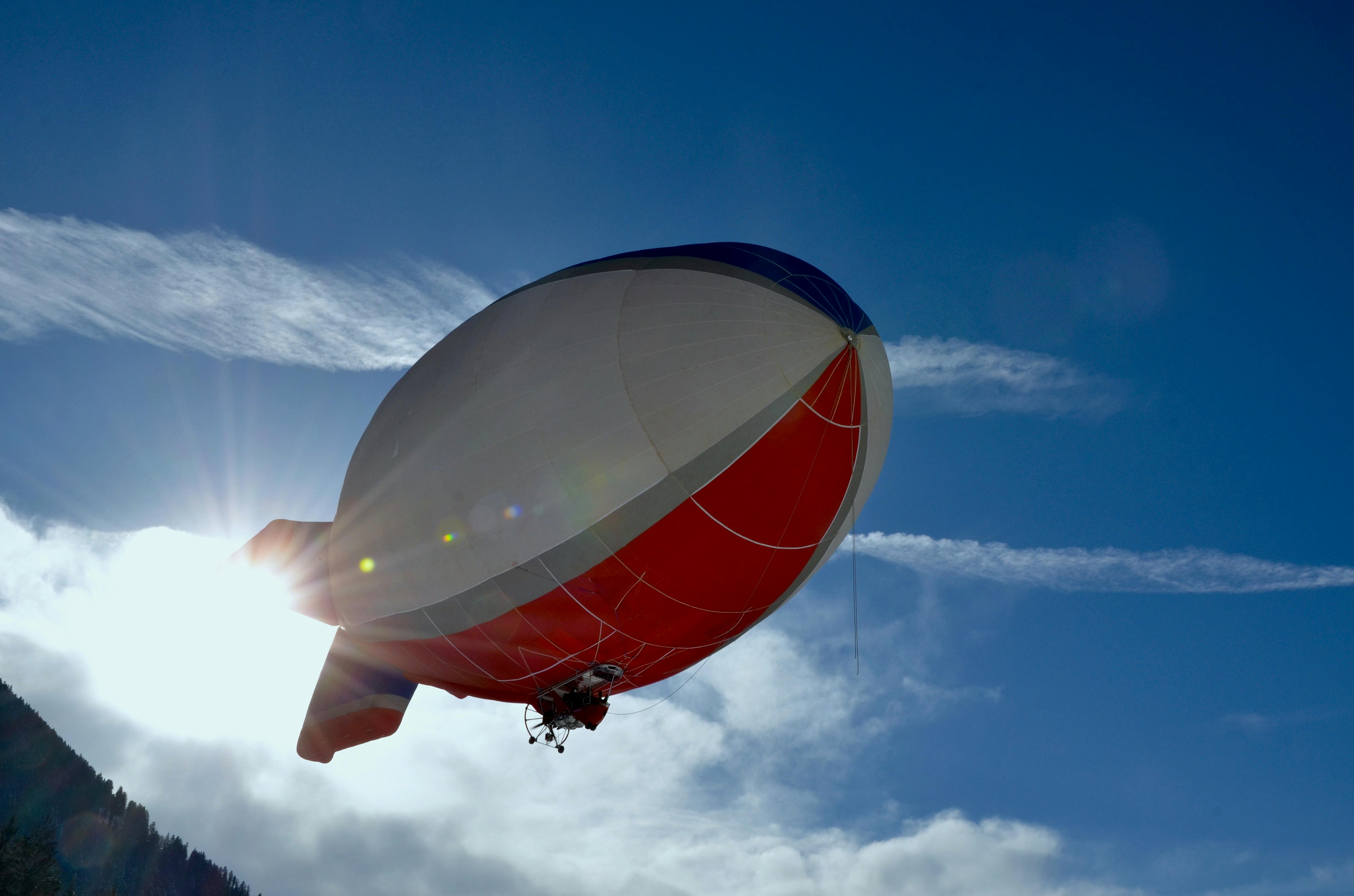 White and Red Blimp Flying · Free Stock Photo