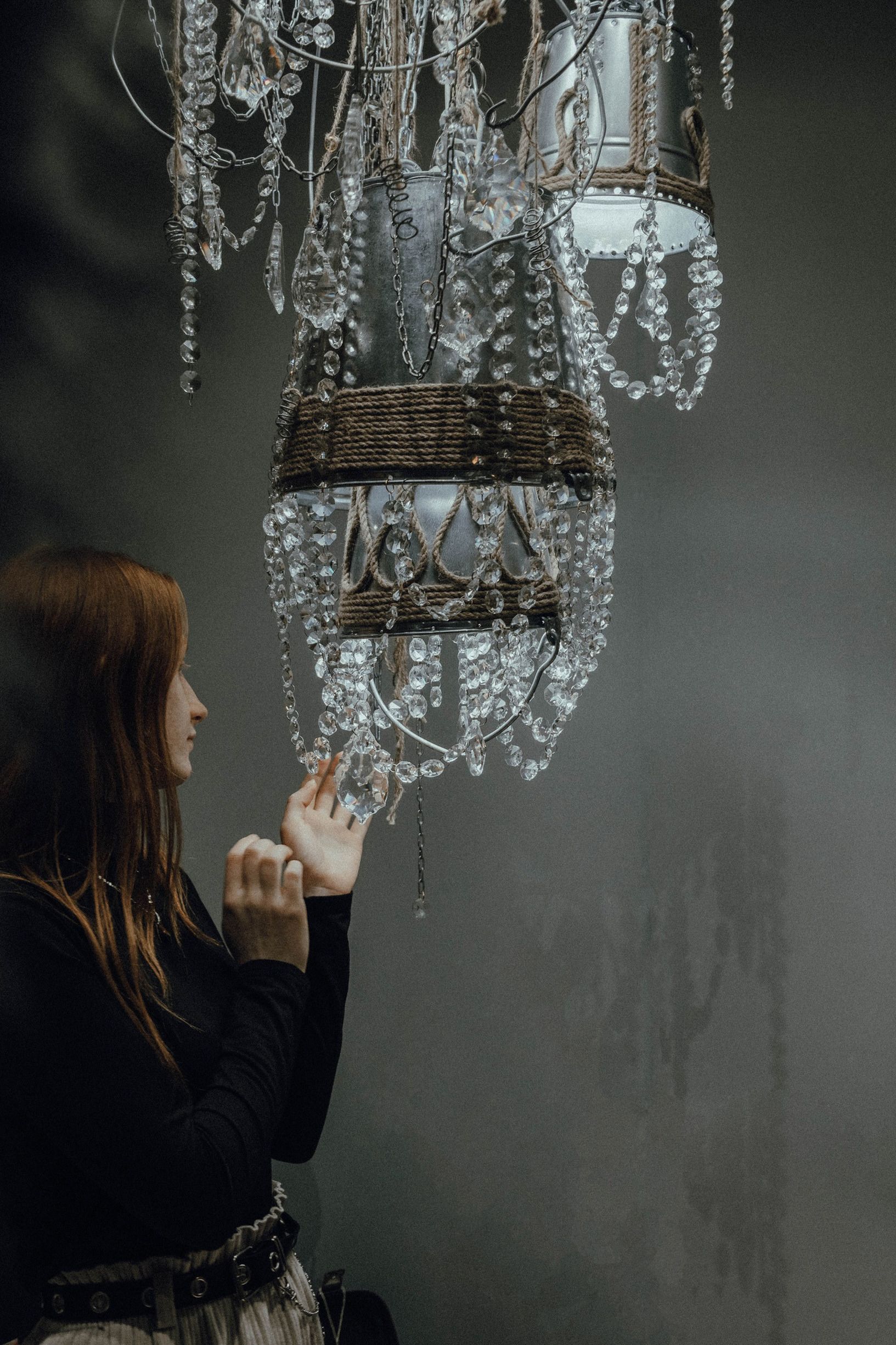 Woman in Black Dress Holding a Chandelier · Free Stock Photo