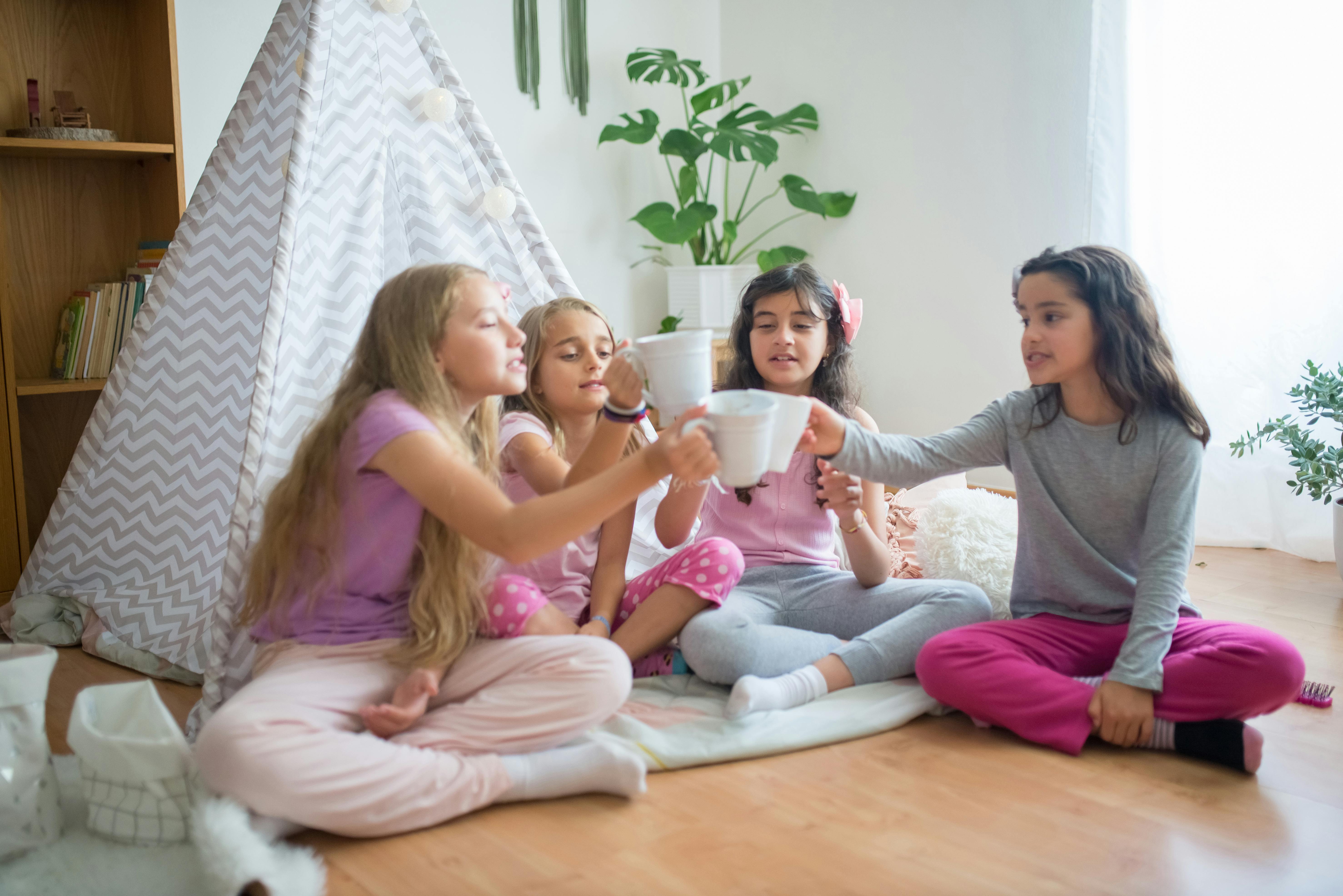 Girls Sitting on the Floor While Doing a Toast · Free Stock Photo