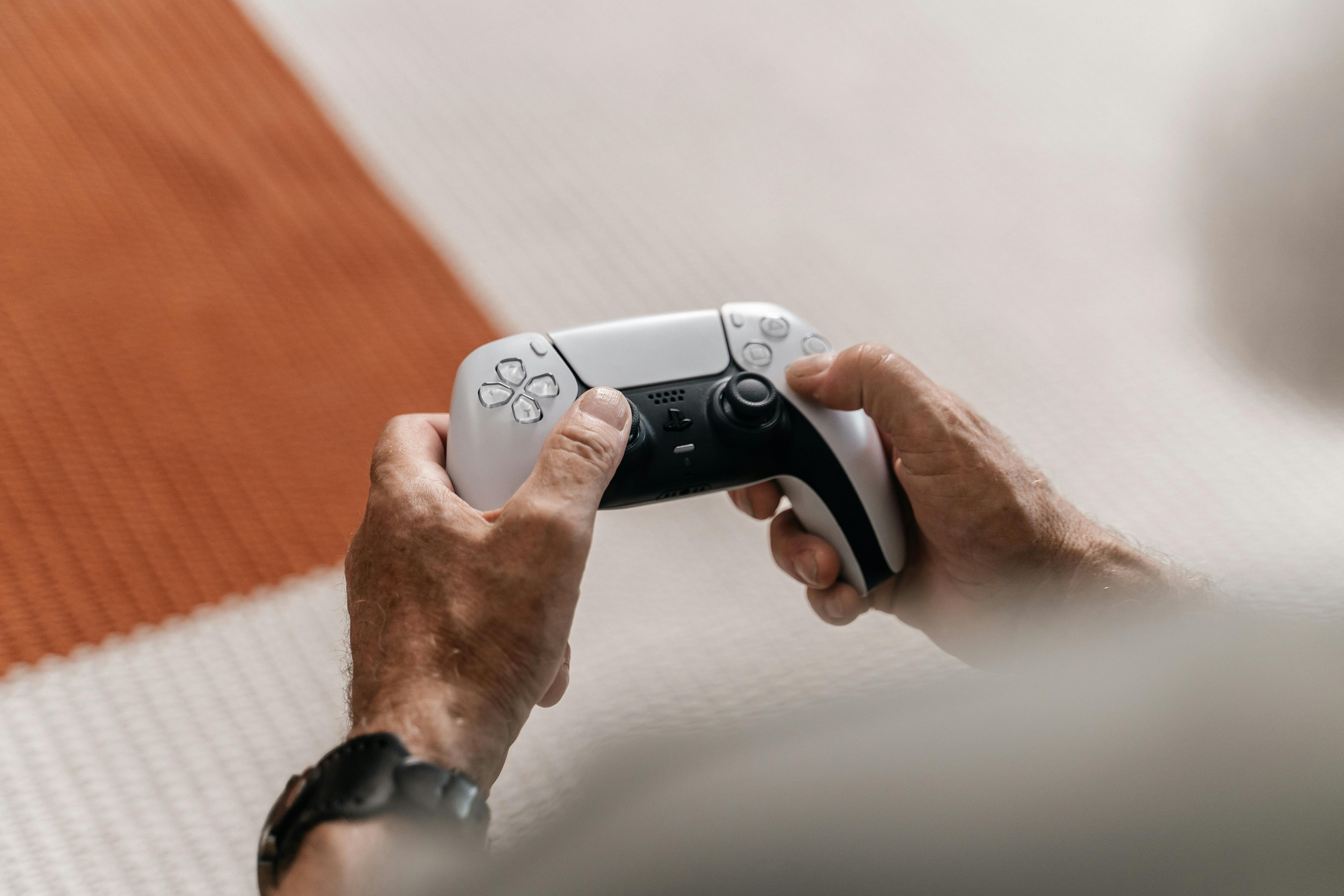 Person Holding Gray and Black Game Controller · Free Stock Photo
