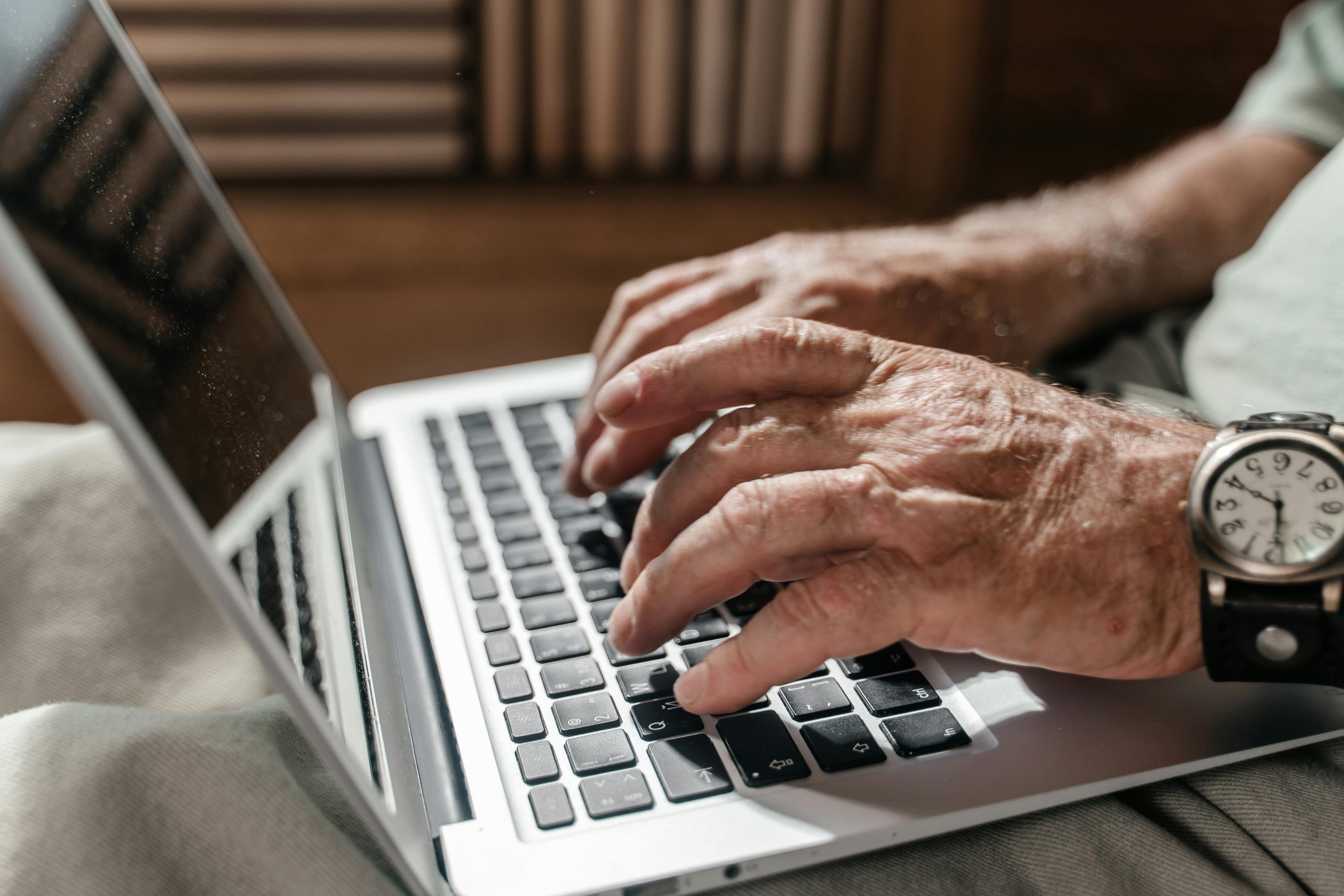 Person Typing a Laptop Computer · Free Stock Photo