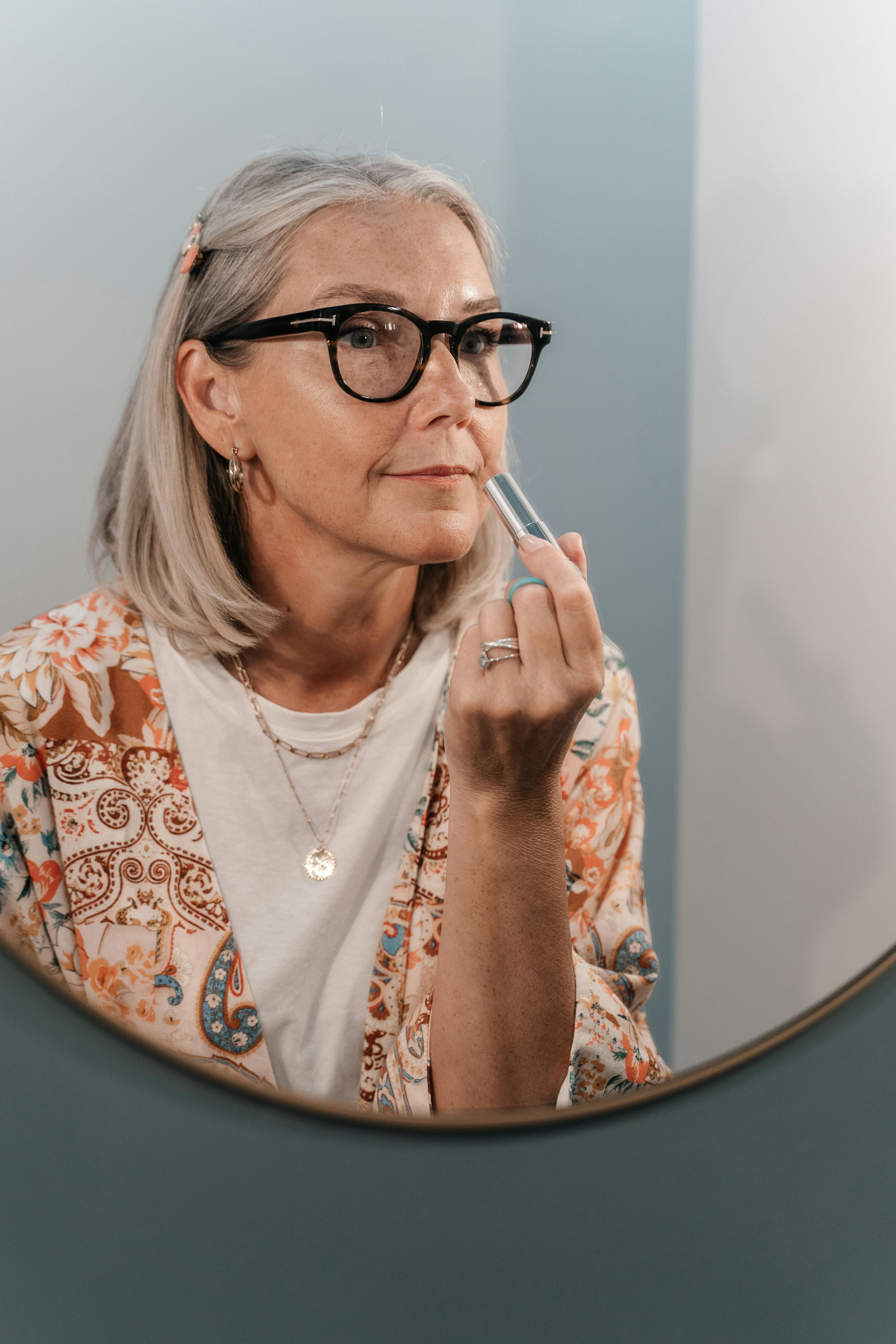 Person Writing on a Mirror Using a Red Lipstick · Free Stock Photo