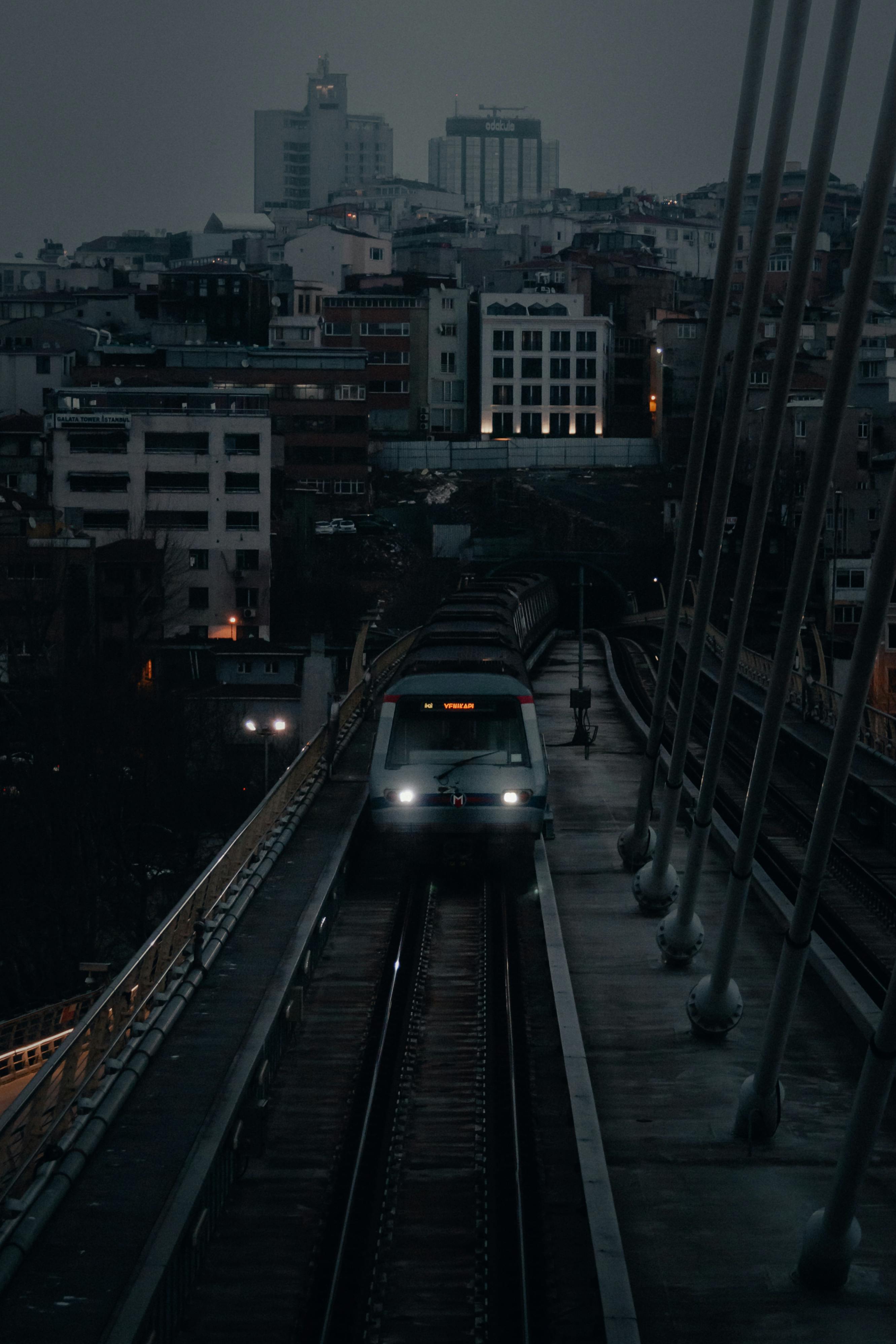 Subway Train Driving Toward a Tunnel With Residential Buildings in the ...