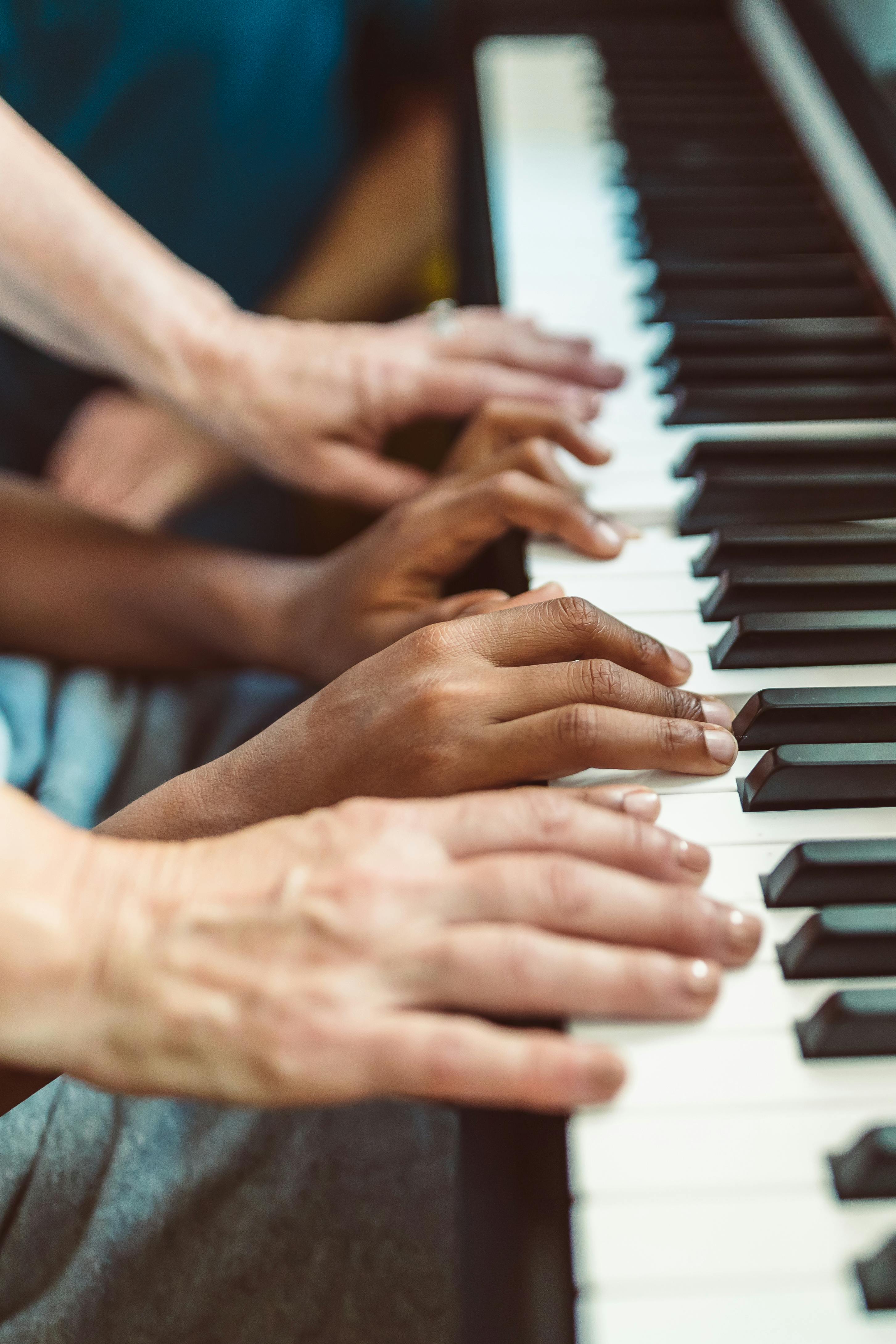 Selective Focus Photo of People Playing Piano · Free Stock Photo