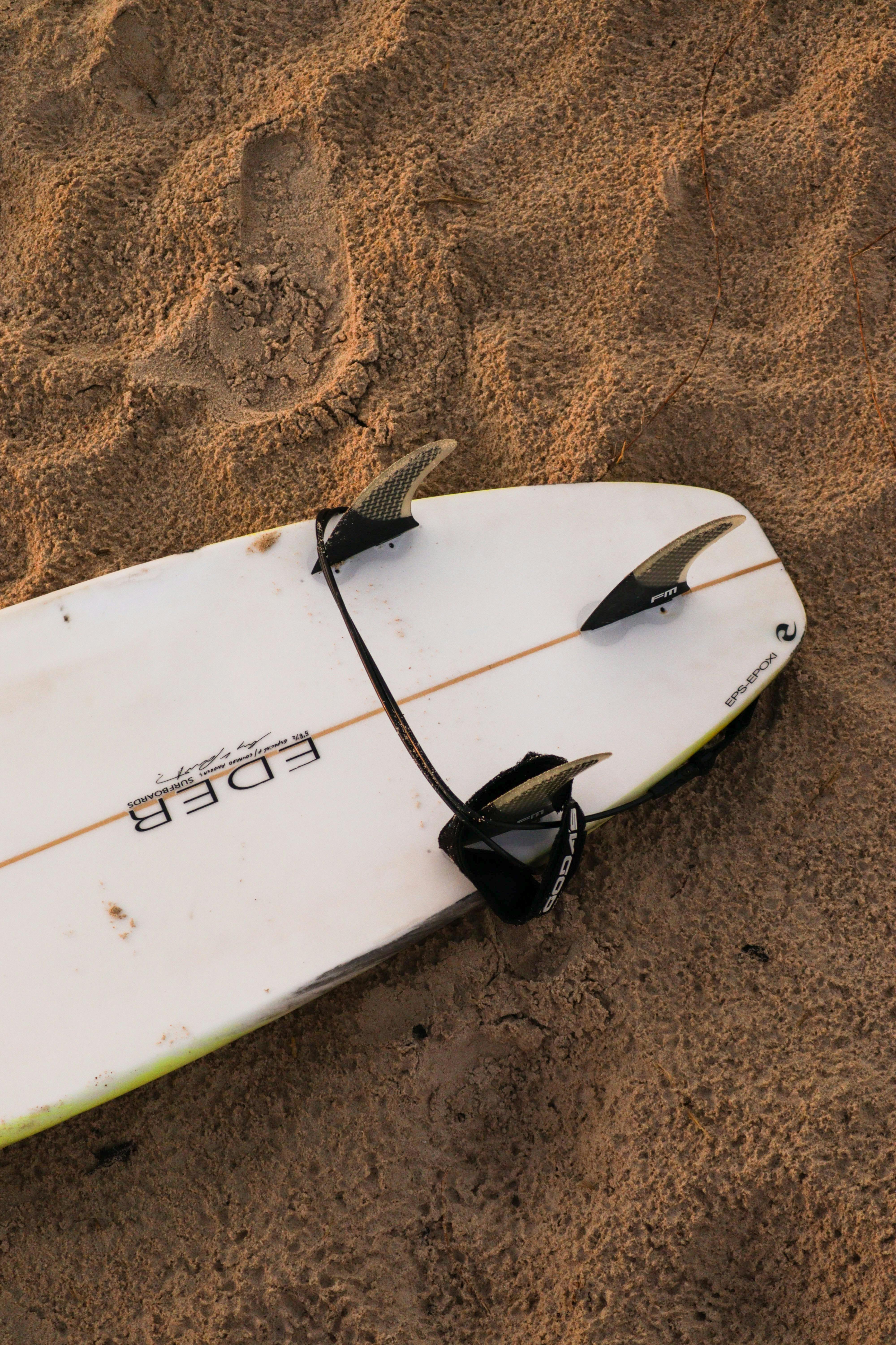 High-Angle Shot of a Surfboard on the Shore · Free Stock Photo