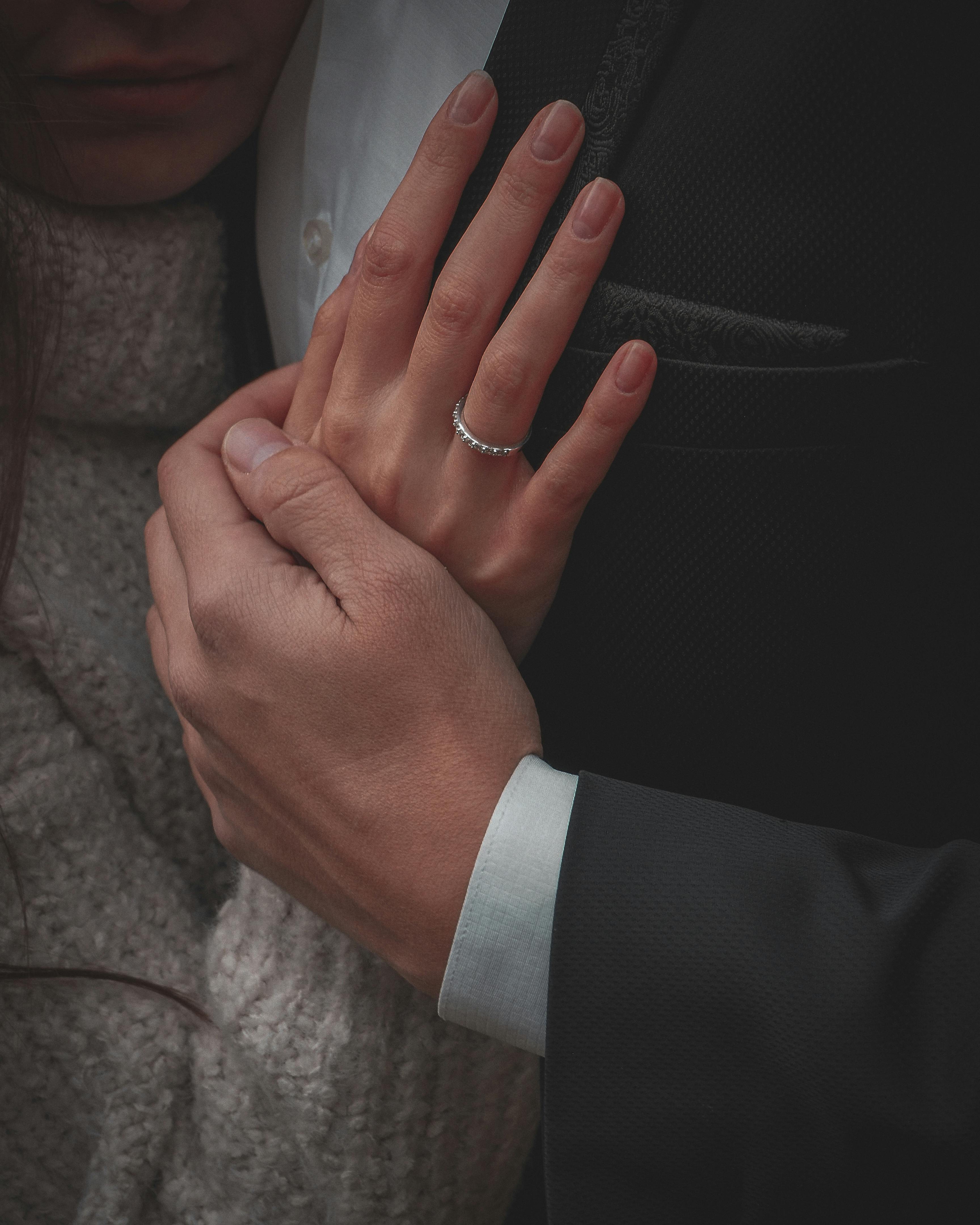 Unrecognizable Couple Cuddling and Holding Hands · Free Stock Photo
