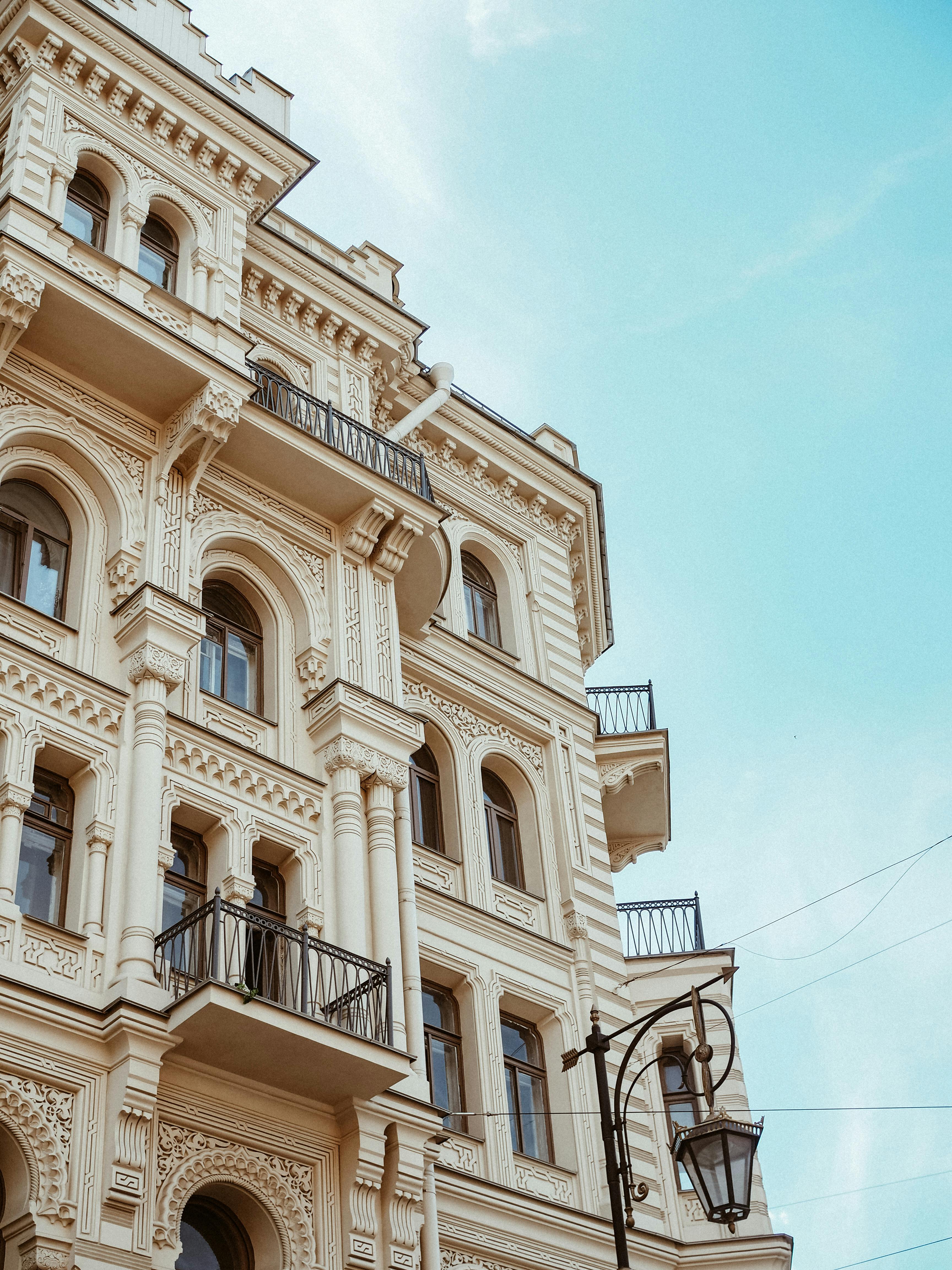 A Beige Concrete Apartment Building Under Blue Sky · Free Stock Photo